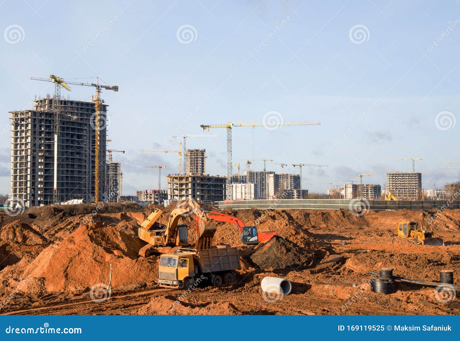 Excavator at a Construction Site on a Background of a Construction ...
