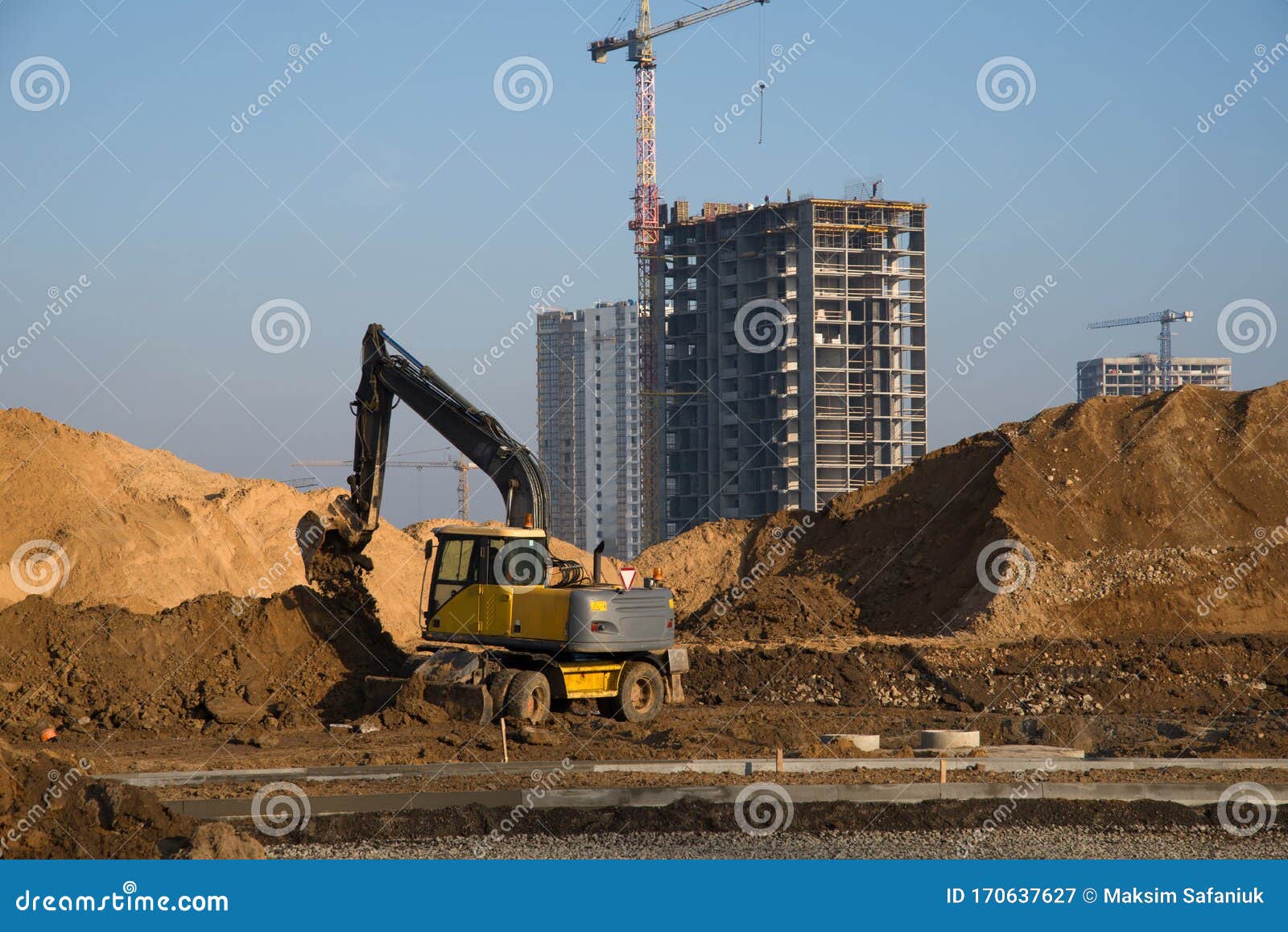 Excavator at a Construction Site on a Background of a Construction ...