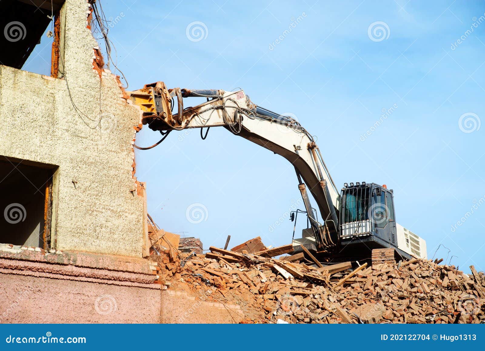 Excavator Demolishing a Brick Building. Machinery Demolishing Building ...