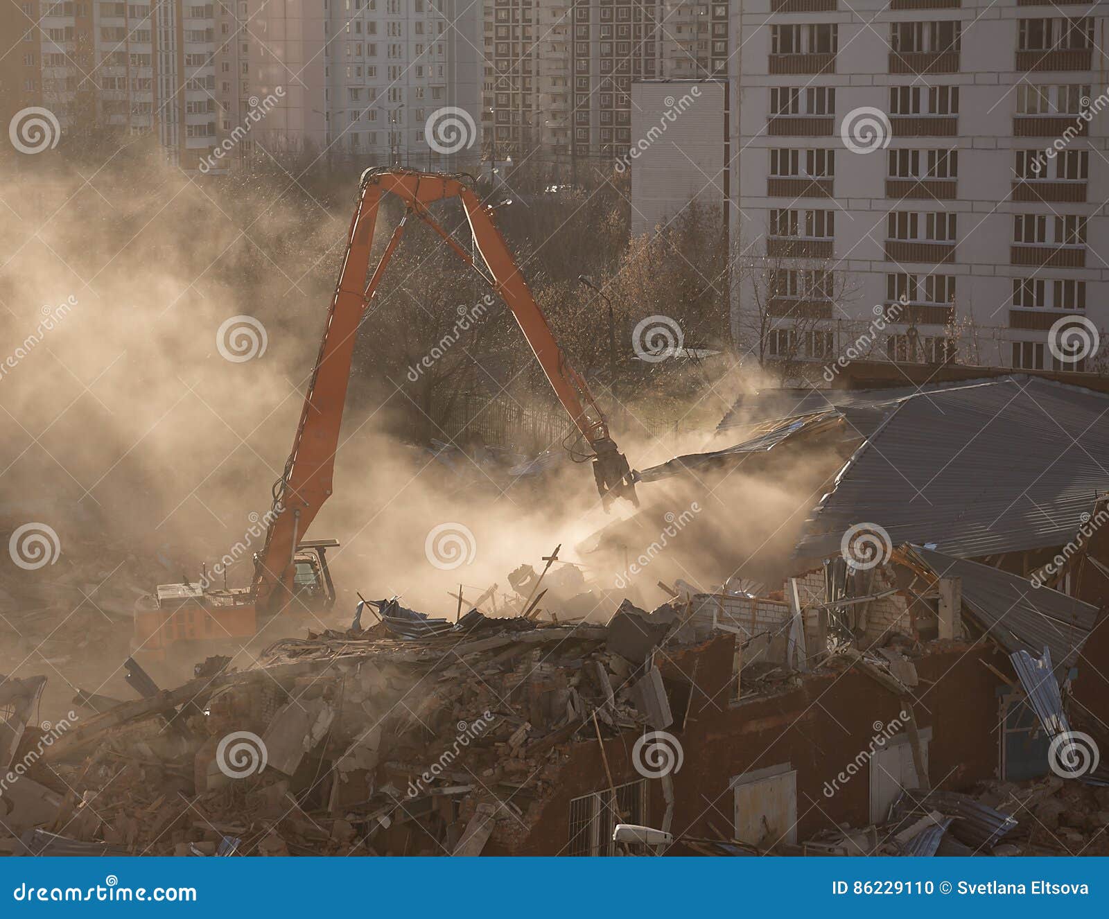 Excavator Demolition in Sunlit Dust Cloud Dismantles the Building in ...