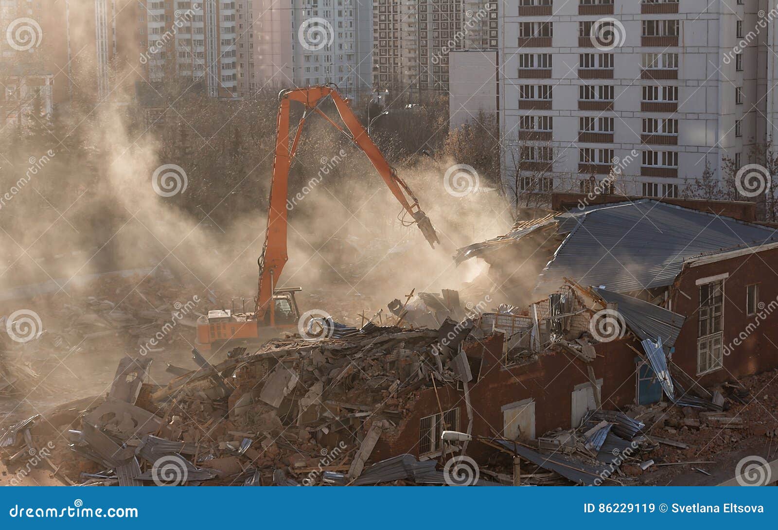 Excavator Demolition in Sunlit Dust Cloud Dismantles the Building in ...