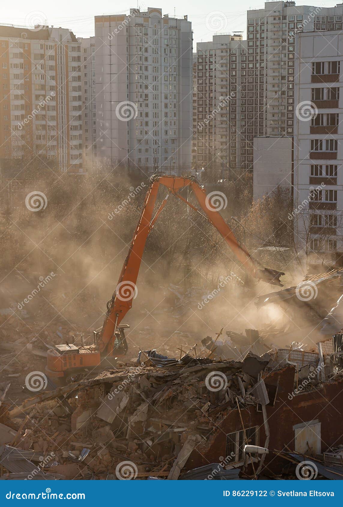 Excavator Demolition in Sunlit Dust Cloud Dismantles the Building in ...