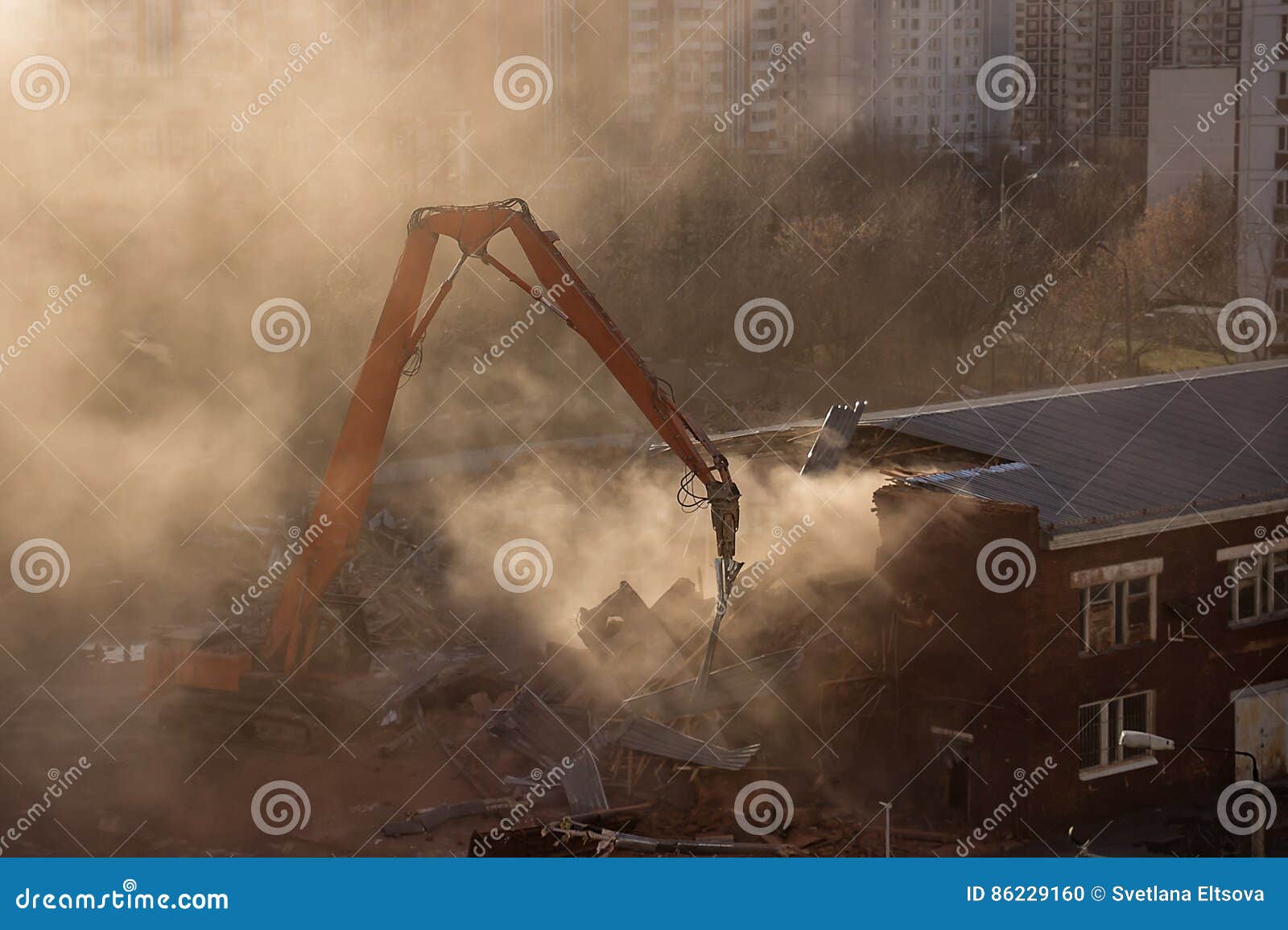 Excavator Demolition in Sunlit Dust Cloud Dismantles the Building in ...