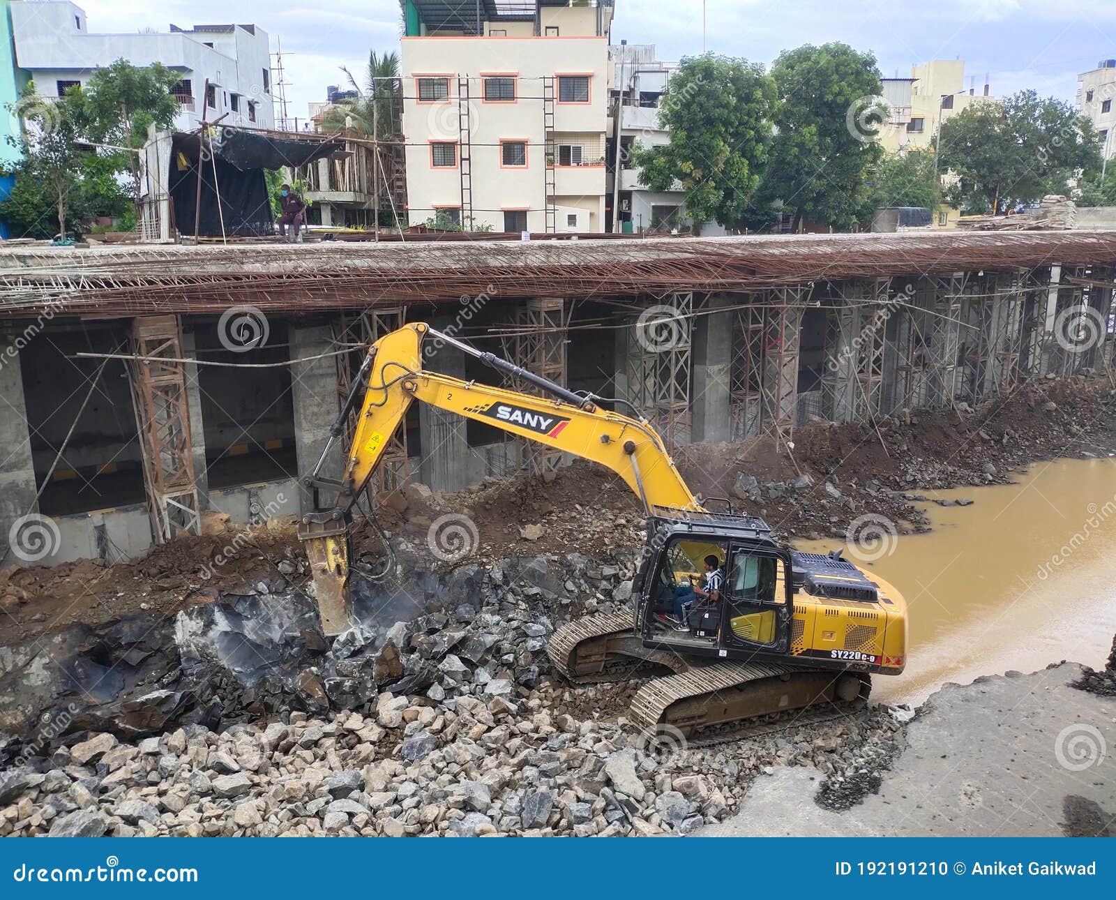 Excavator Digging and Breaking Stones in Underground Construction Site ...