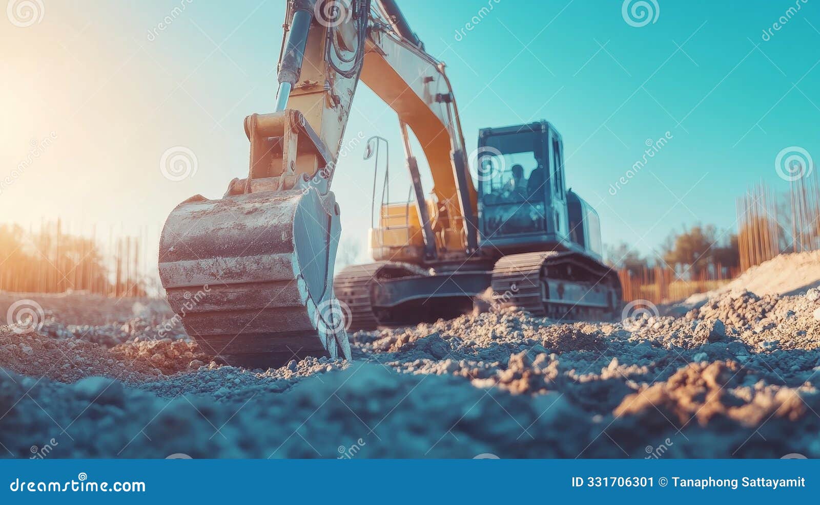 Excavator Digging in Construction Site at Sunset an Excavator Digging ...
