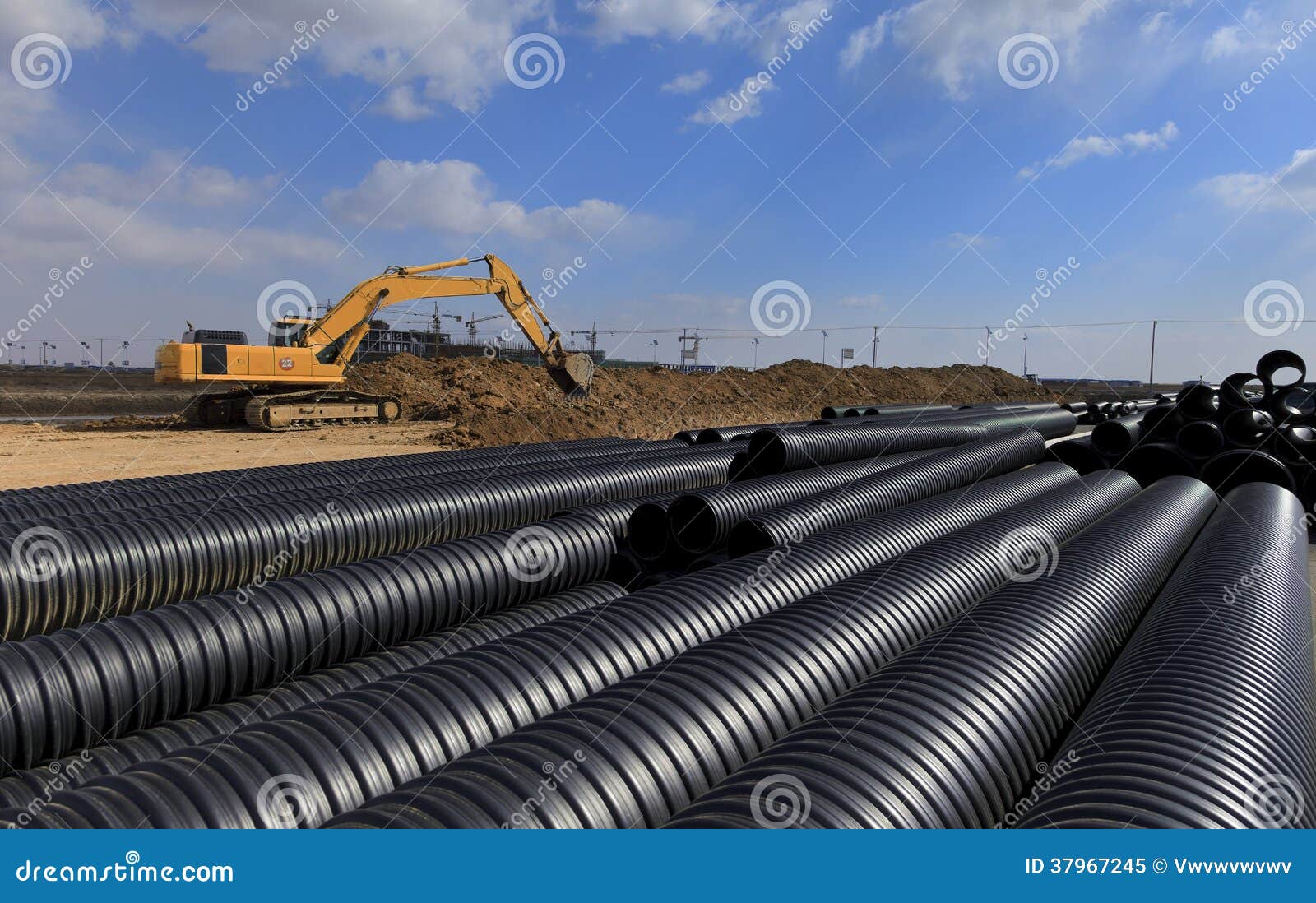 An Excavator is Digging a Ditch Alongside a Newly Built Road Stock ...