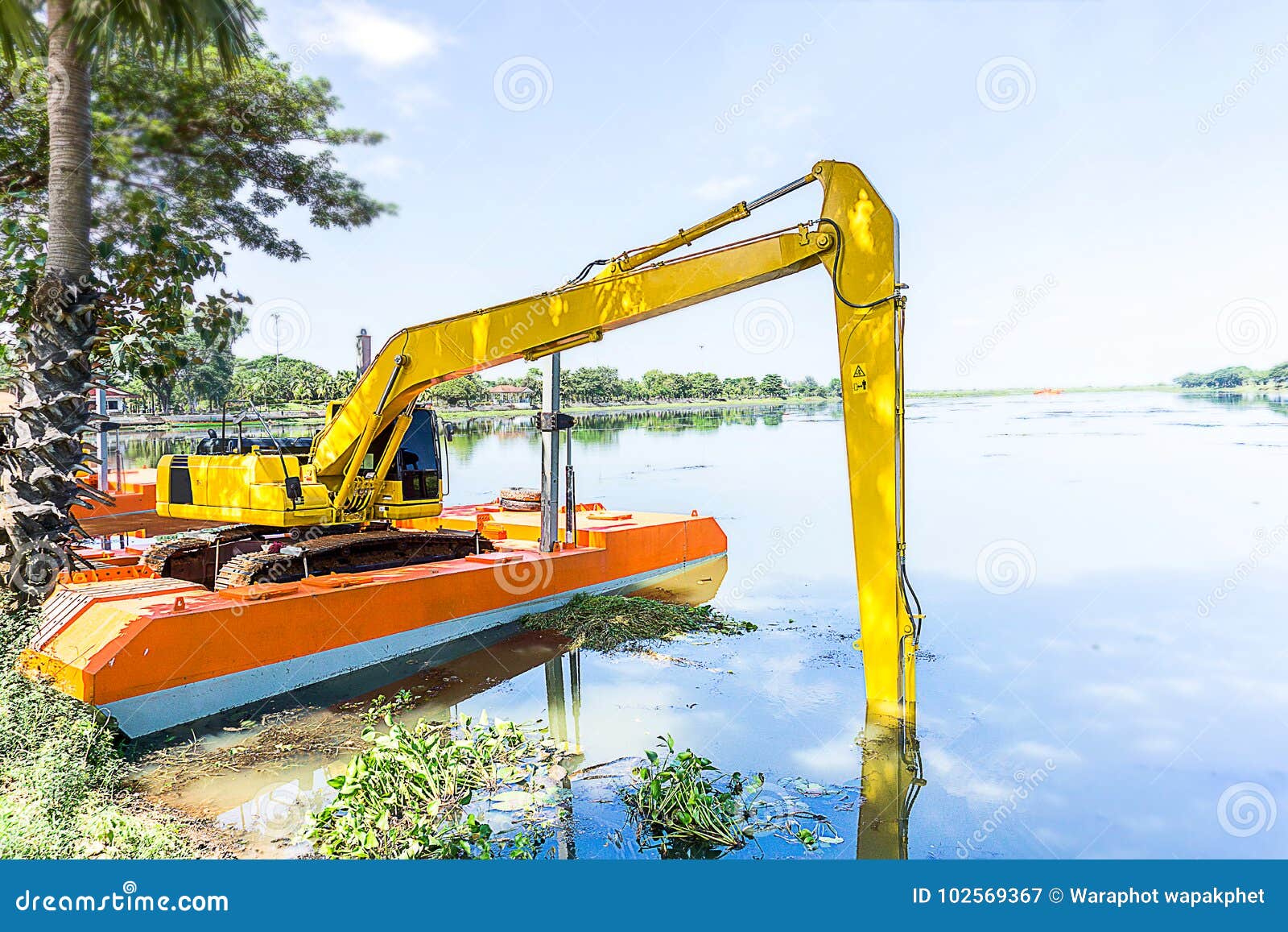 The Excavator is Digging the Edge of the Water Again. Stock Image ...