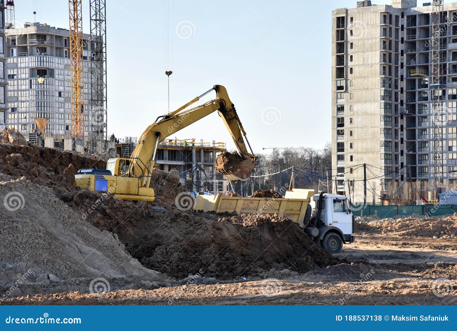 Excavator Digging Sand and Loading into Dump Truck on Construction Site ...