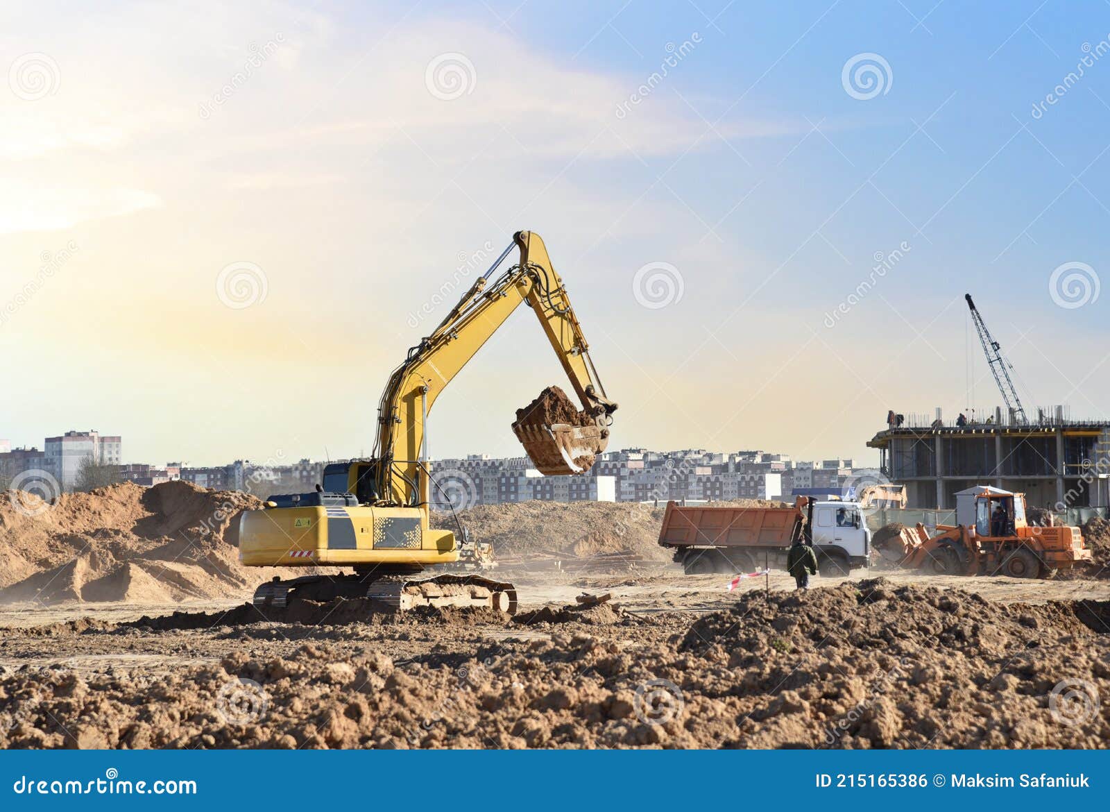 Excavator Digging Sand and Loading into Dump Truck on Construction Site ...