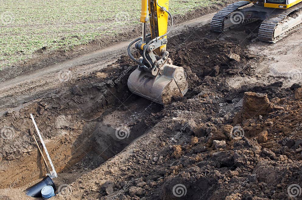 Excavator digging trench stock photo. Image of mound - 18866926