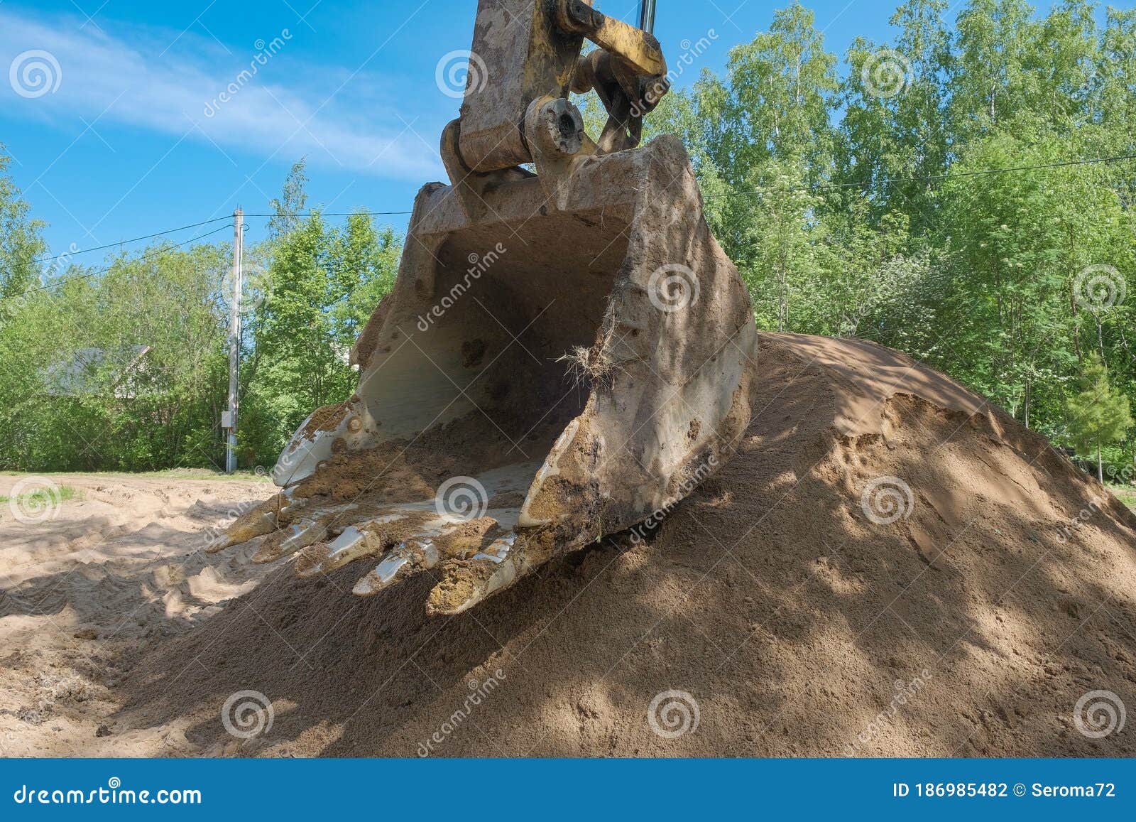 Excavator Digs Clay Soil at the Construction Site Stock Photo - Image ...