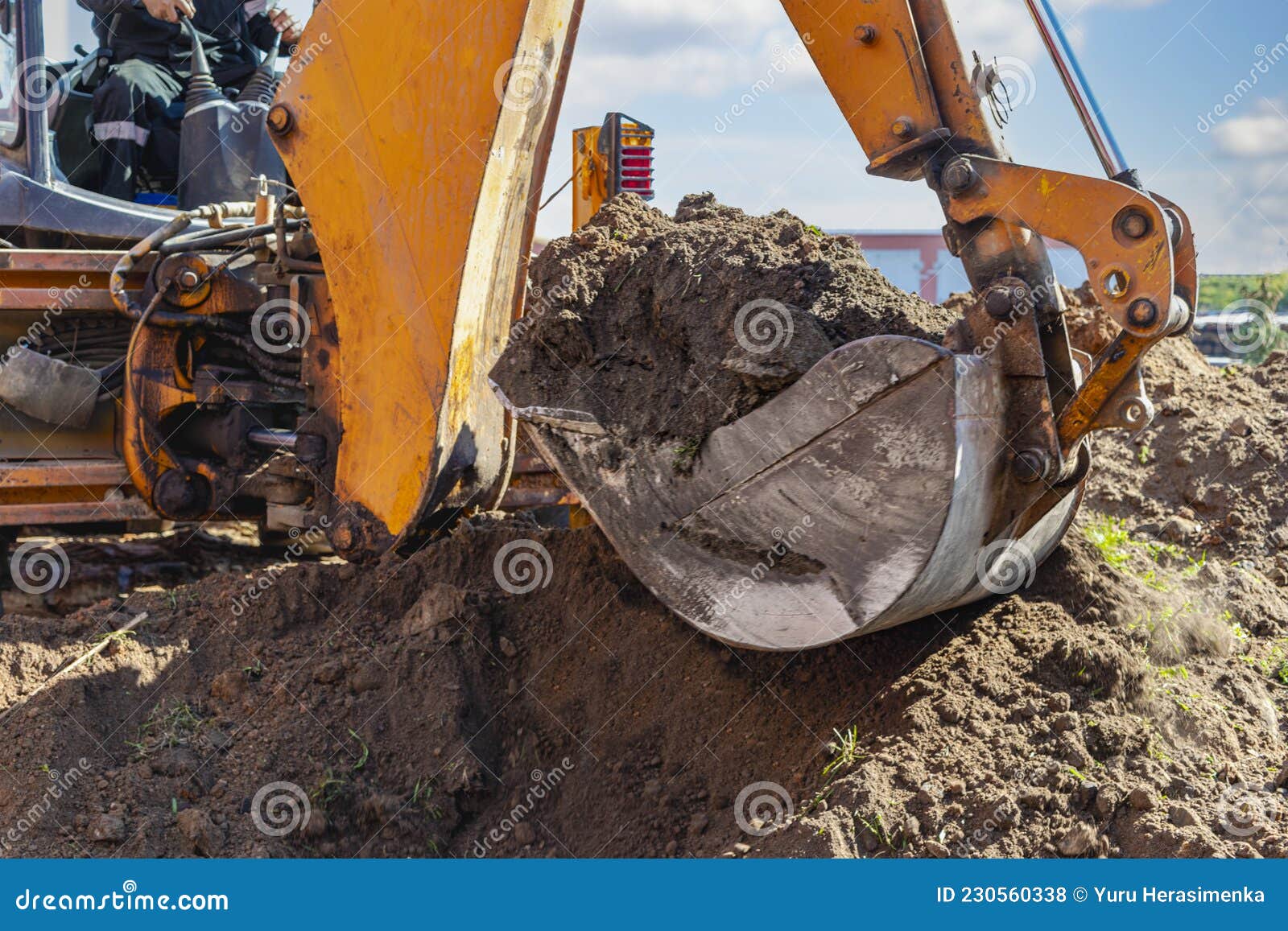 The Excavator Digs a Deep Foundation Pit. Close-up Stock Photo - Image ...