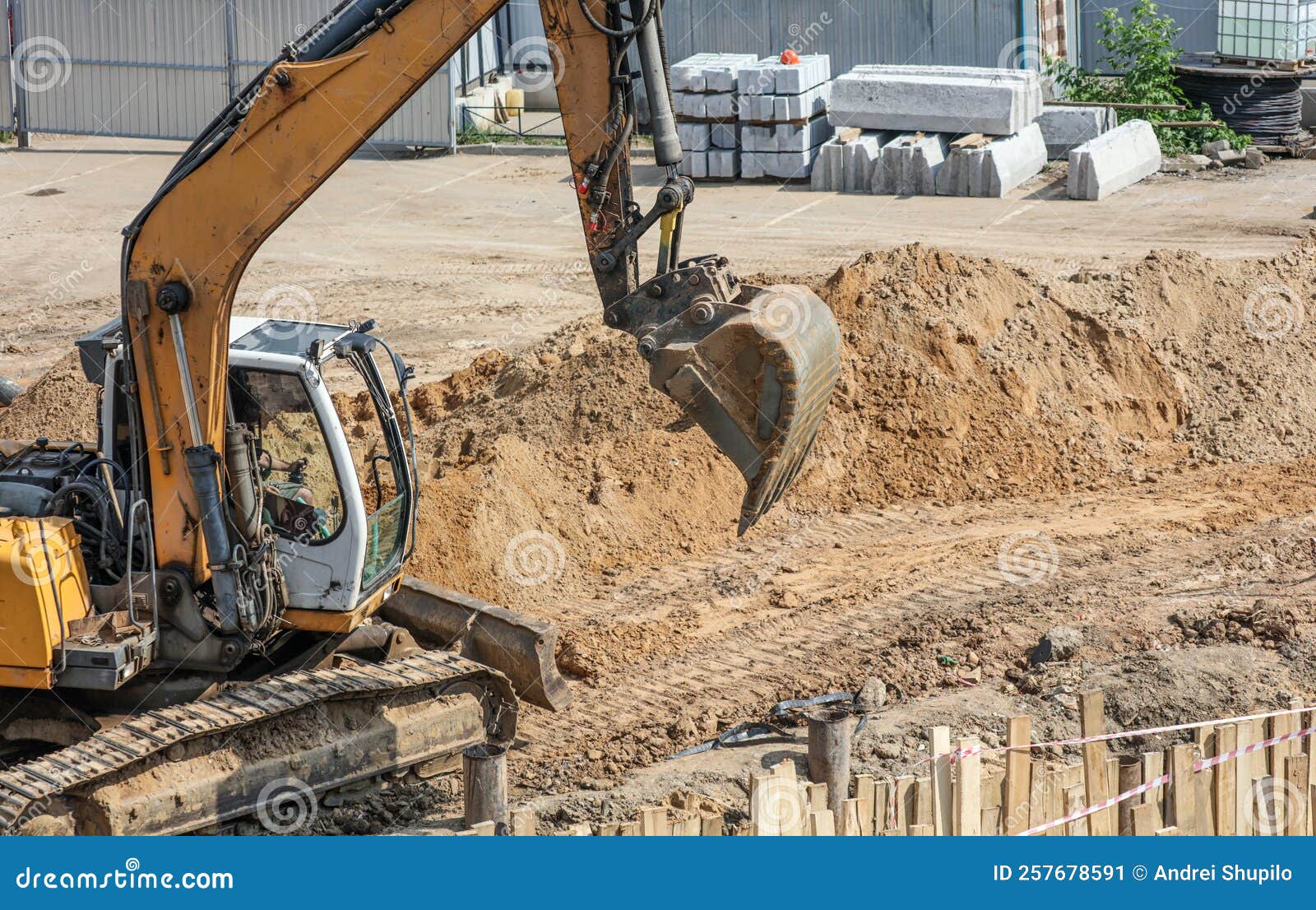 Excavator Digs the Ground at a Construction Site. Stock Image - Image ...