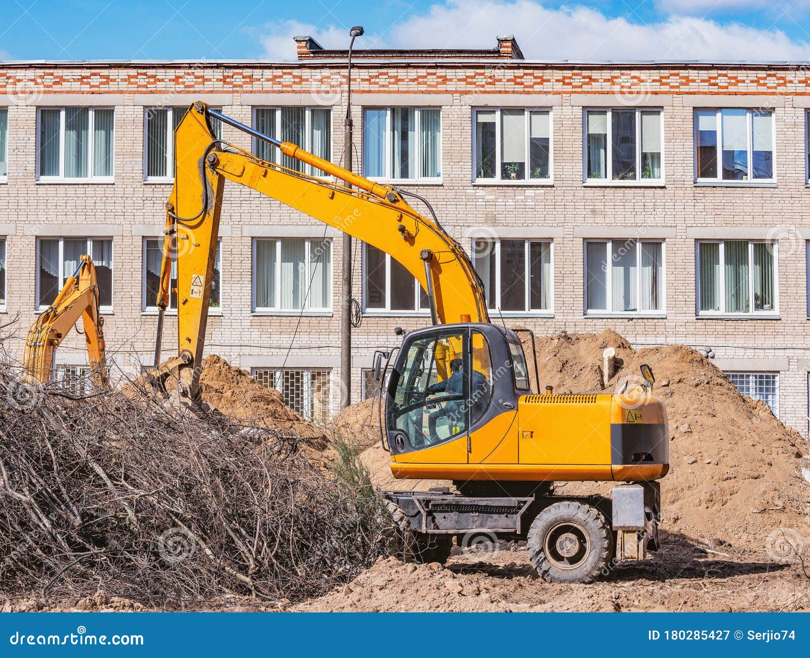 Excavator Digs a Hole on the Construction Site. Stock Image - Image of ...