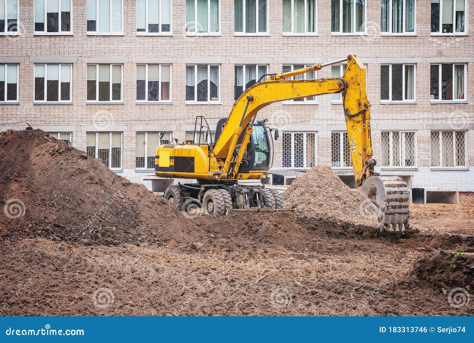 Excavator digs a hole. stock photo. Image of mining - 183313746