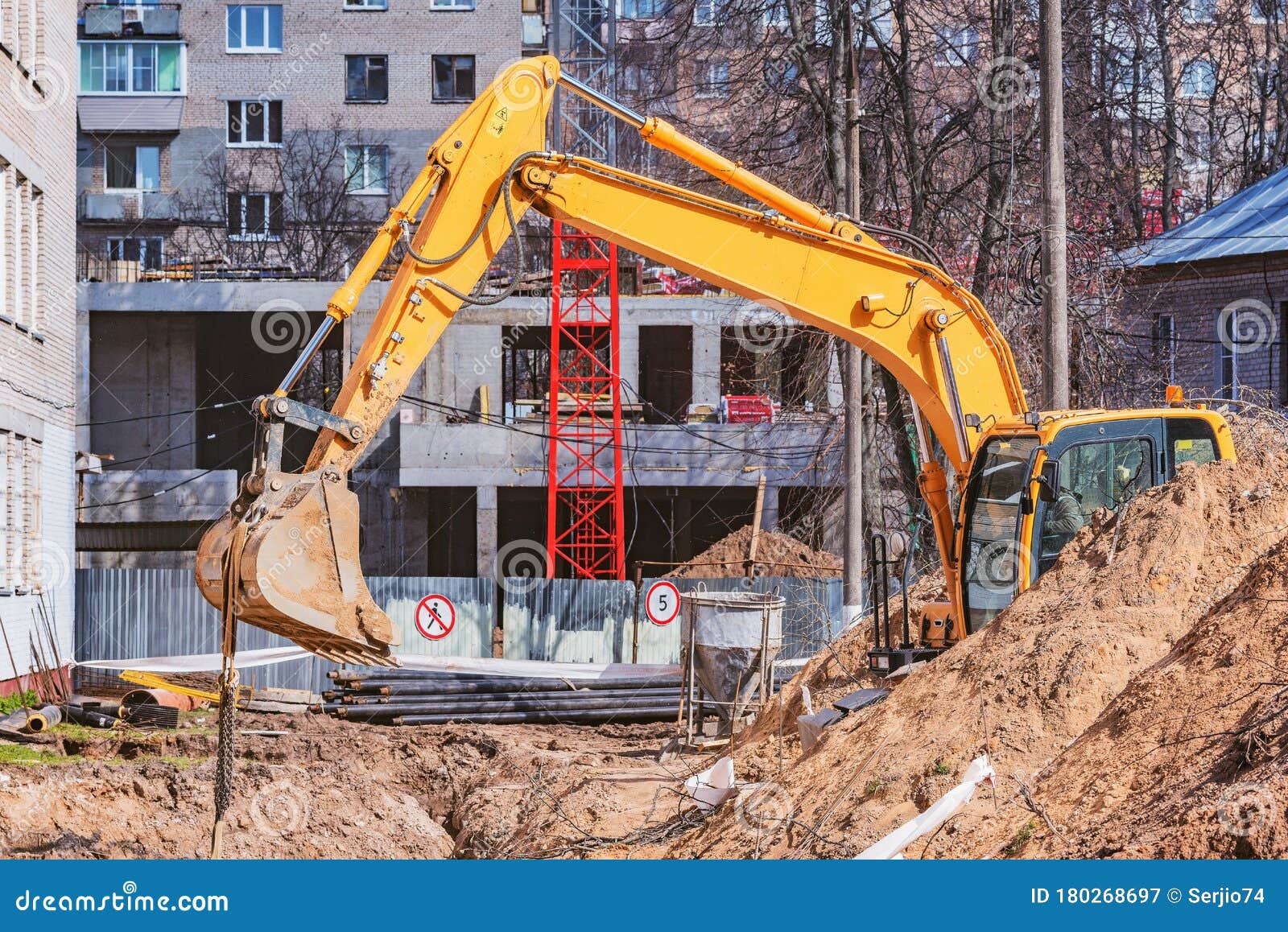 Excavator Digs a Hole on the Construction Site. Stock Image - Image of ...