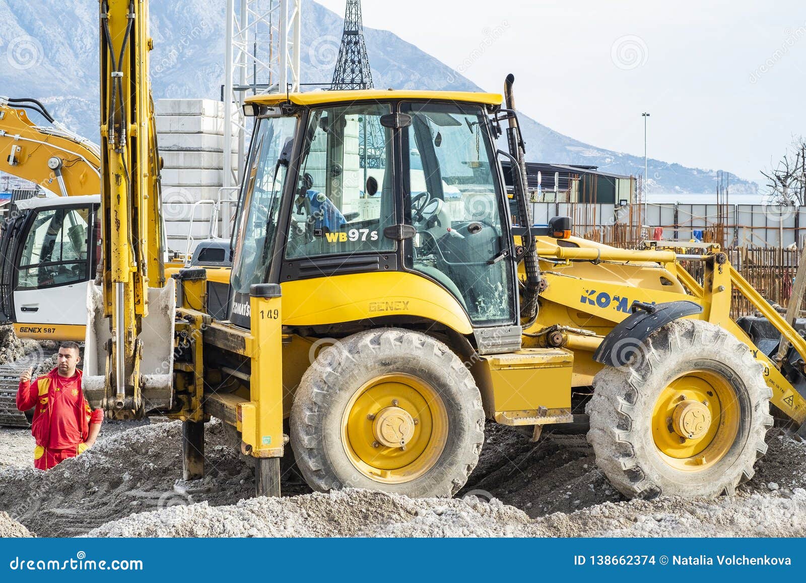 Excavator Digs a Pit, a Worker is Directing the Work Editorial Stock ...