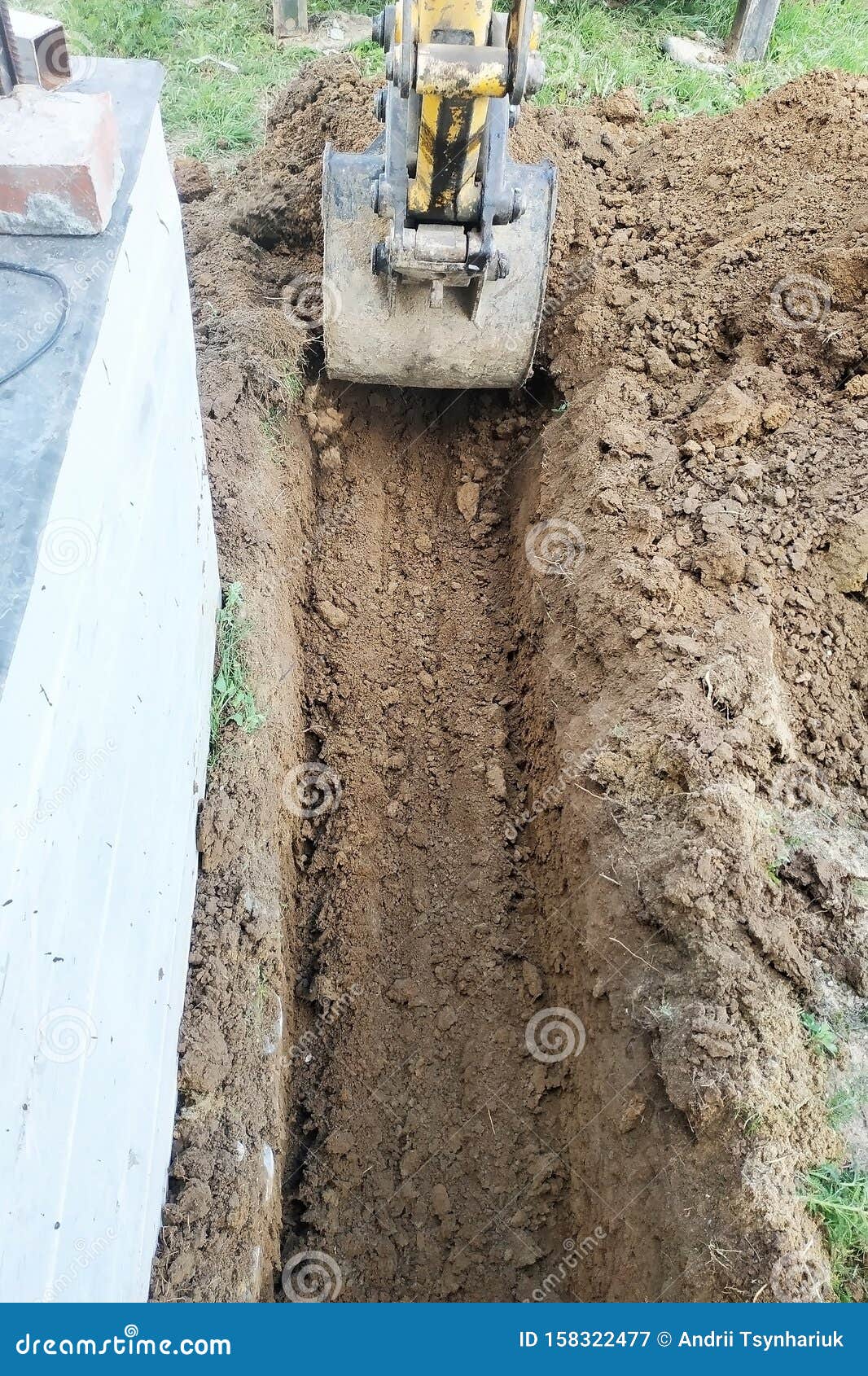 The Excavator Digs a Small Trench in the Yard Stock Image - Image of ...