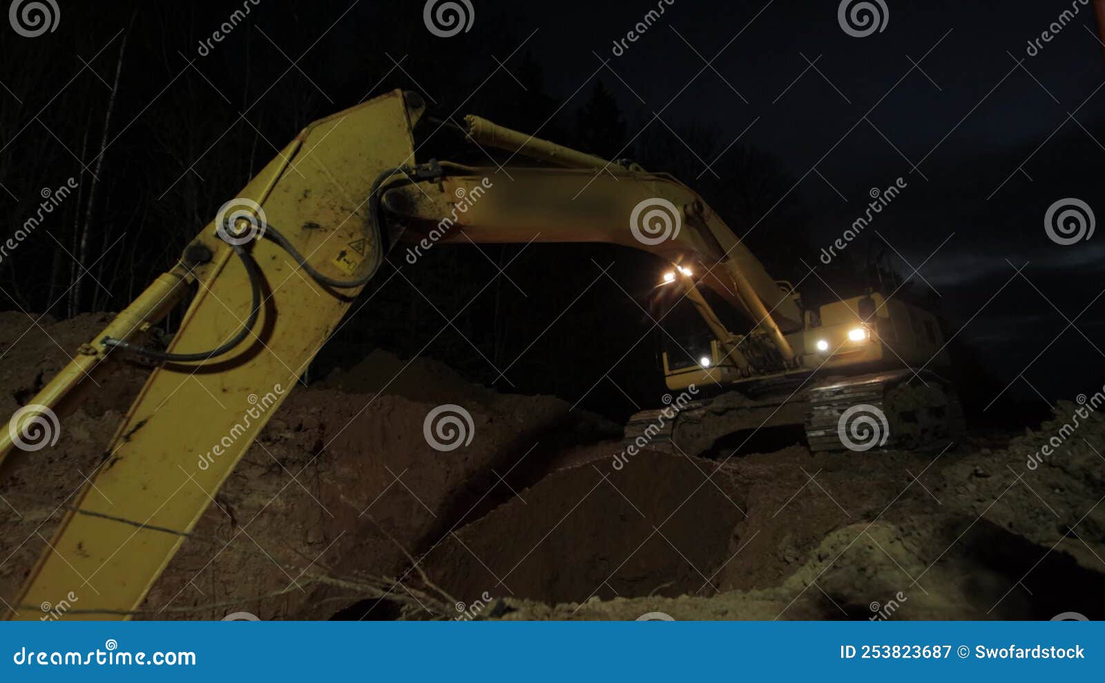 Excavator Digs a Trench with Headlights at Night. Work at Night. Night ...