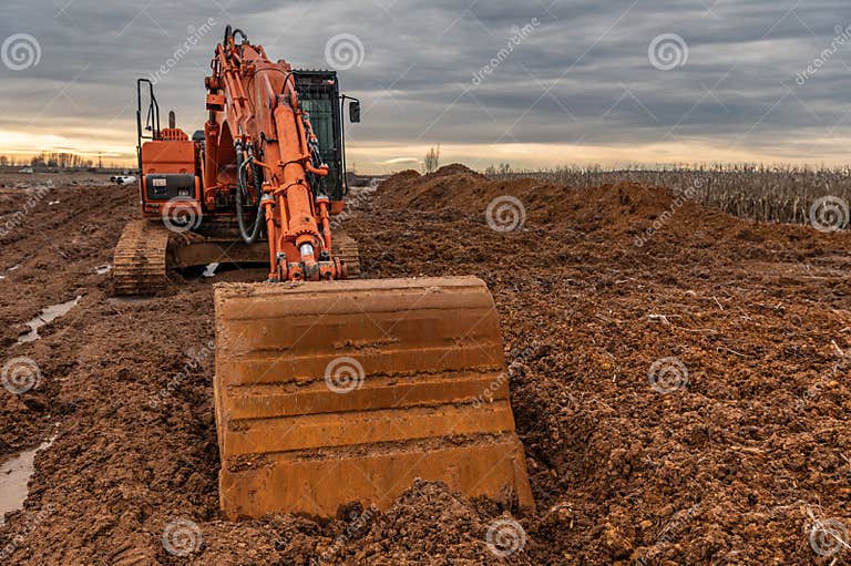 Excavator Doing Work on a Wet and Muddy Winter Day Stock Image - Image ...