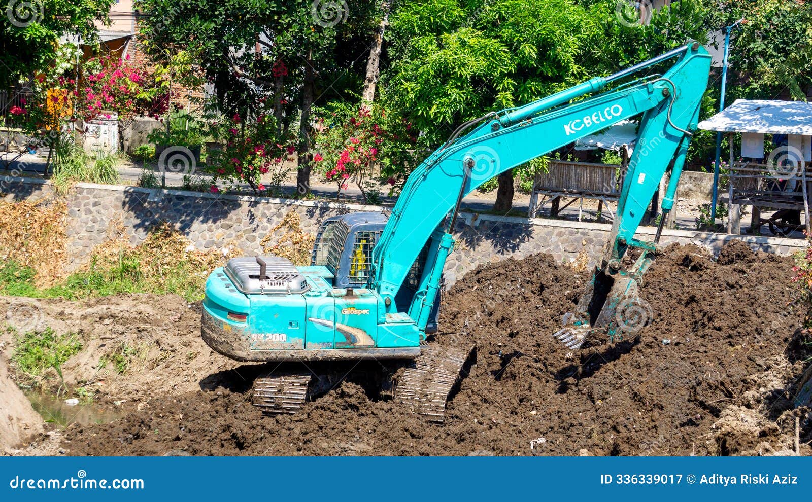 Excavator Driver is Digging Soil in the River To Make the Water Flow ...
