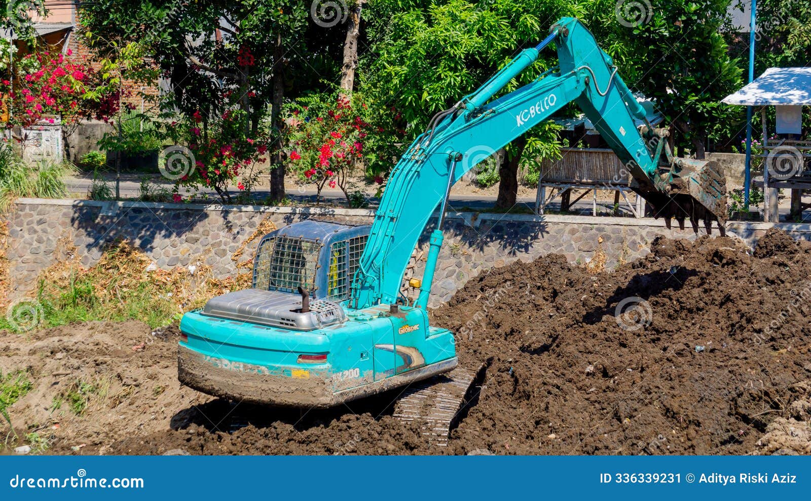 Excavator Driver is Digging Soil in the River To Make the Water Flow ...