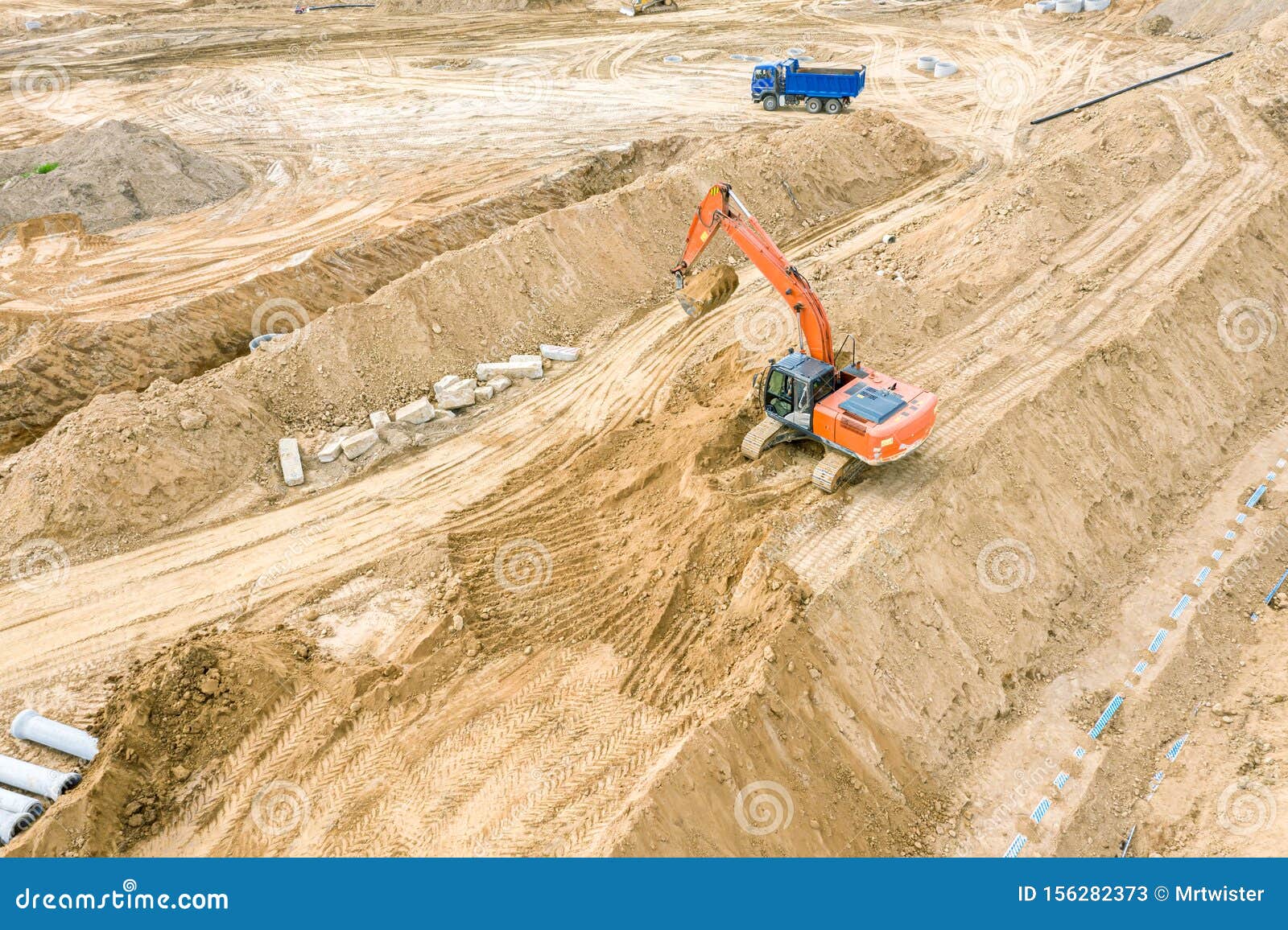 Excavator and Dump Truck Working at Construction Site Stock Image ...