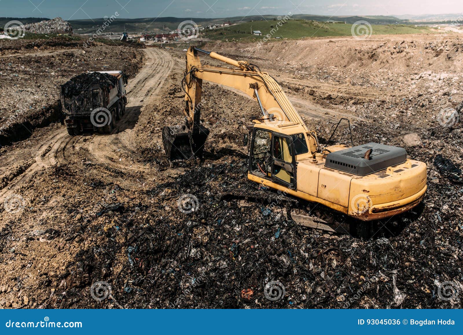Excavator and Dumper Truck Working on Modern Garbage Construction Site ...