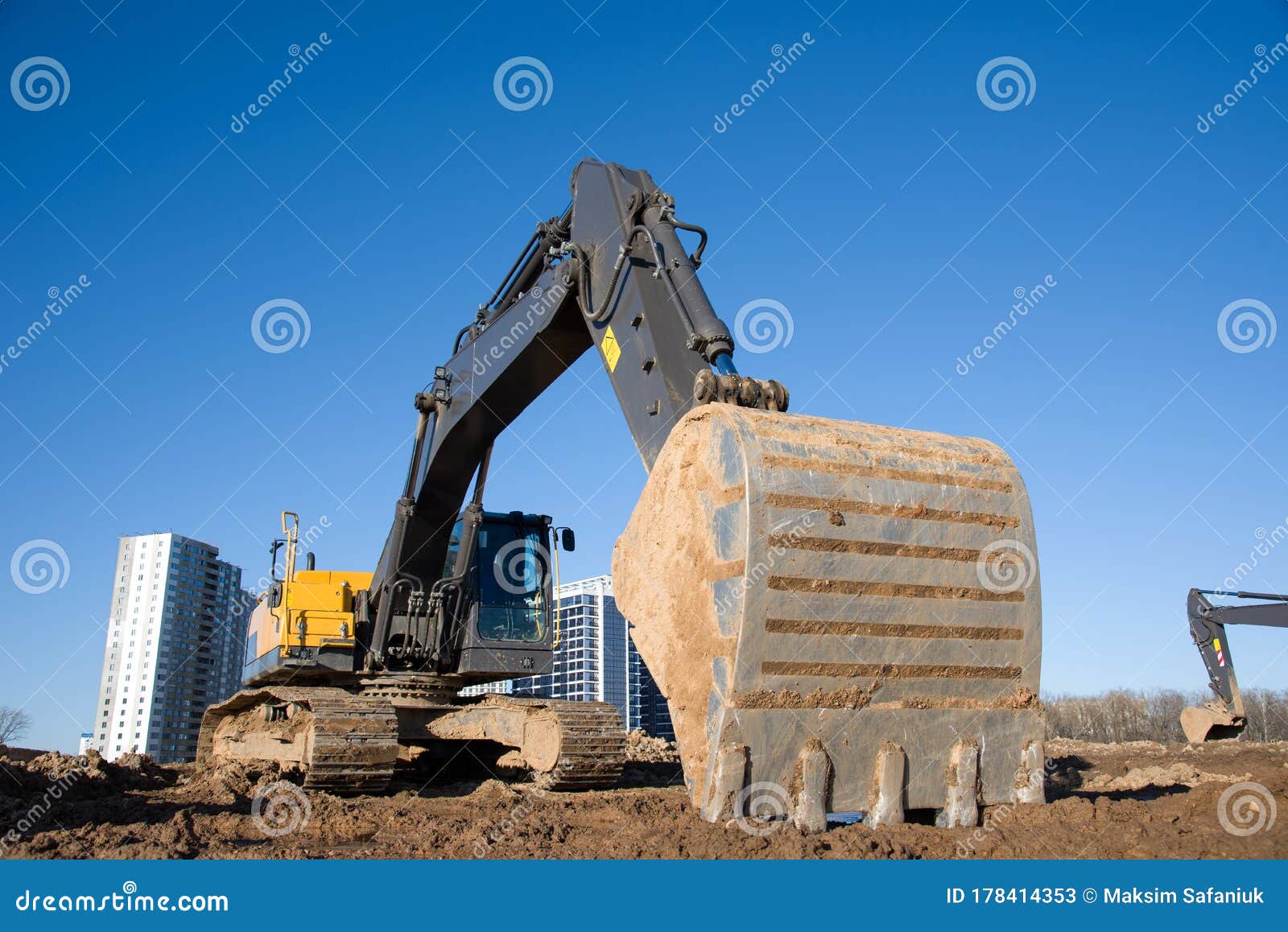 Excavator during Earthmoving at Construction Site on Blue Sky ...
