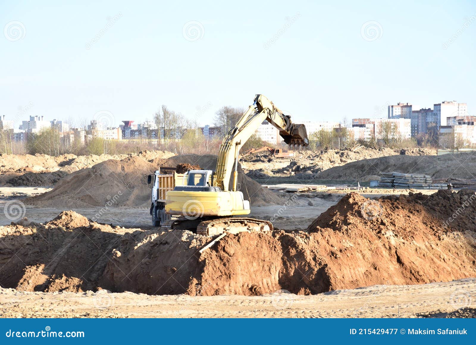 Excavator during Earthmoving Work at Construction Site. Backhoe Digging ...