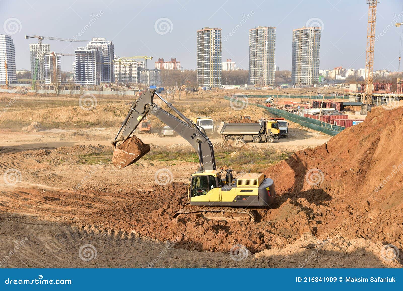 Excavator during Earthmoving Work at Construction Site. Backhoe Digging ...