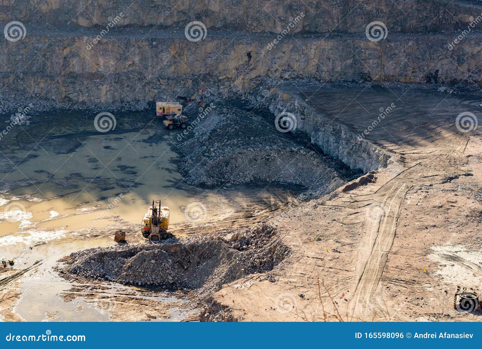 Excavator and Heavy Mining Truck in a Granite Quarry Stock Photo ...