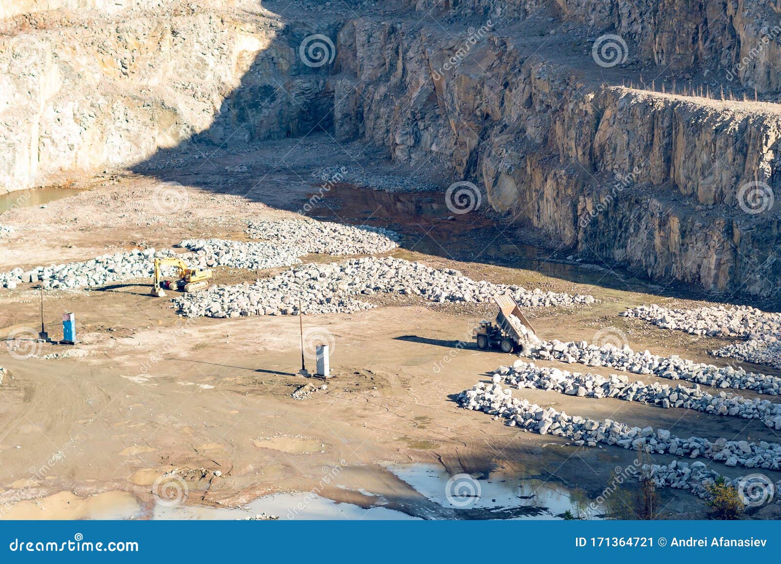 Excavator and Heavy Mining Truck in a Granite Quarry Stock Image ...