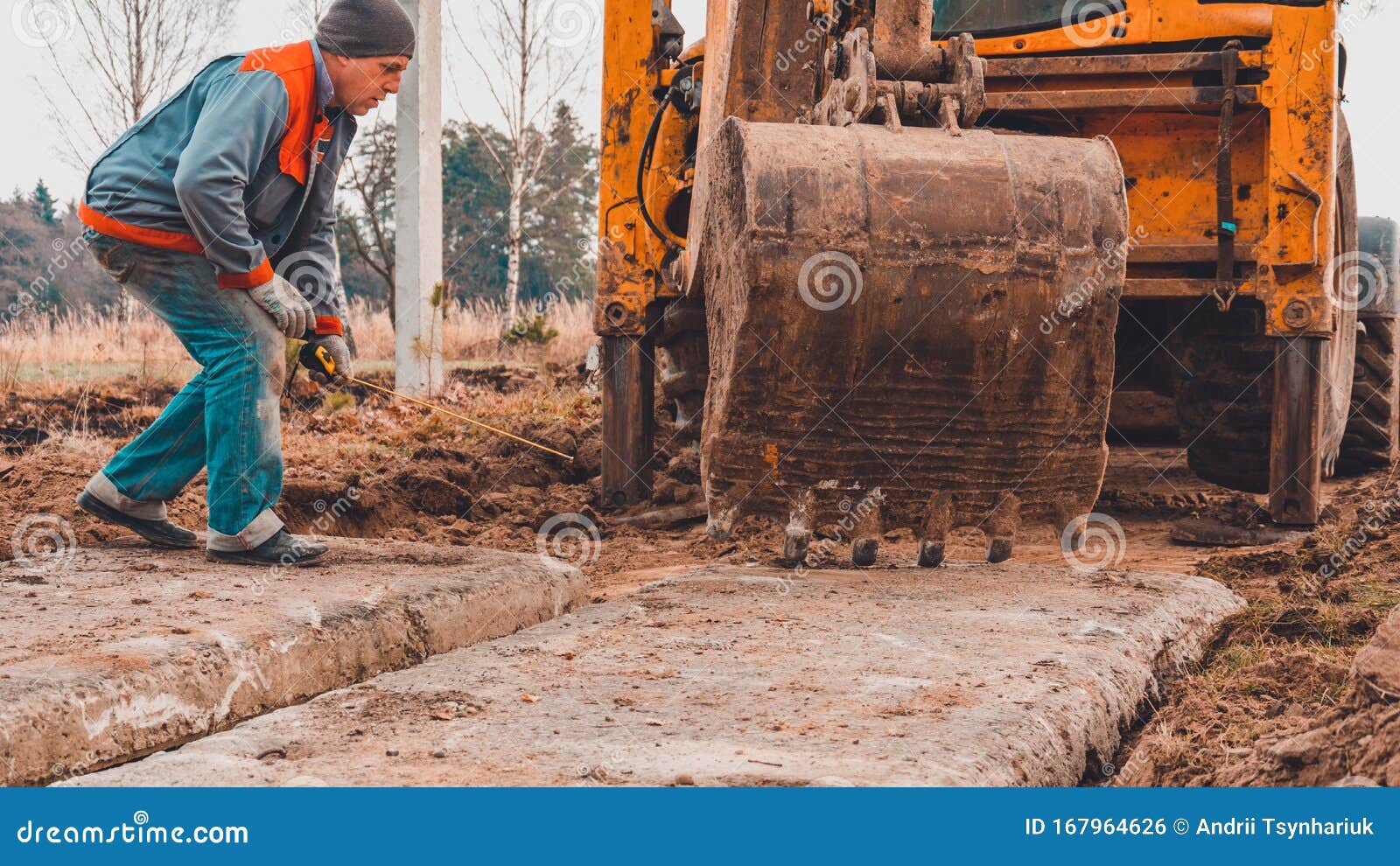 The Excavator Installs Concrete Slabs for the Road Stock Photo - Image ...