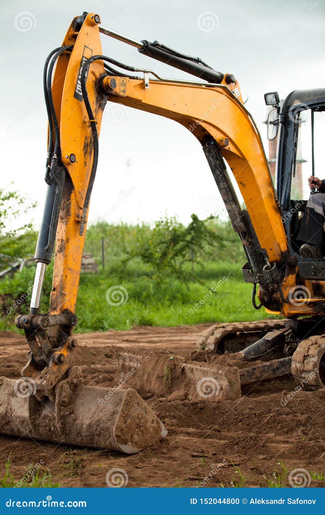 The Excavator Levels the Earth on the Plot Bucket Stock Photo - Image ...