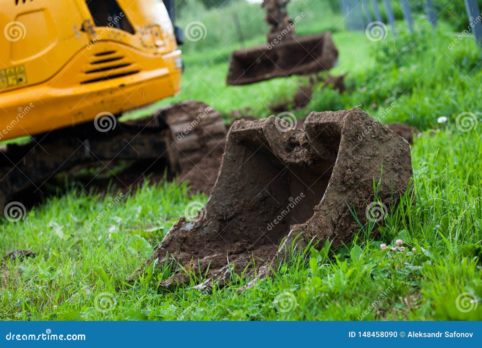 The Excavator Levels the Earth on the Site Stock Photo - Image of ...