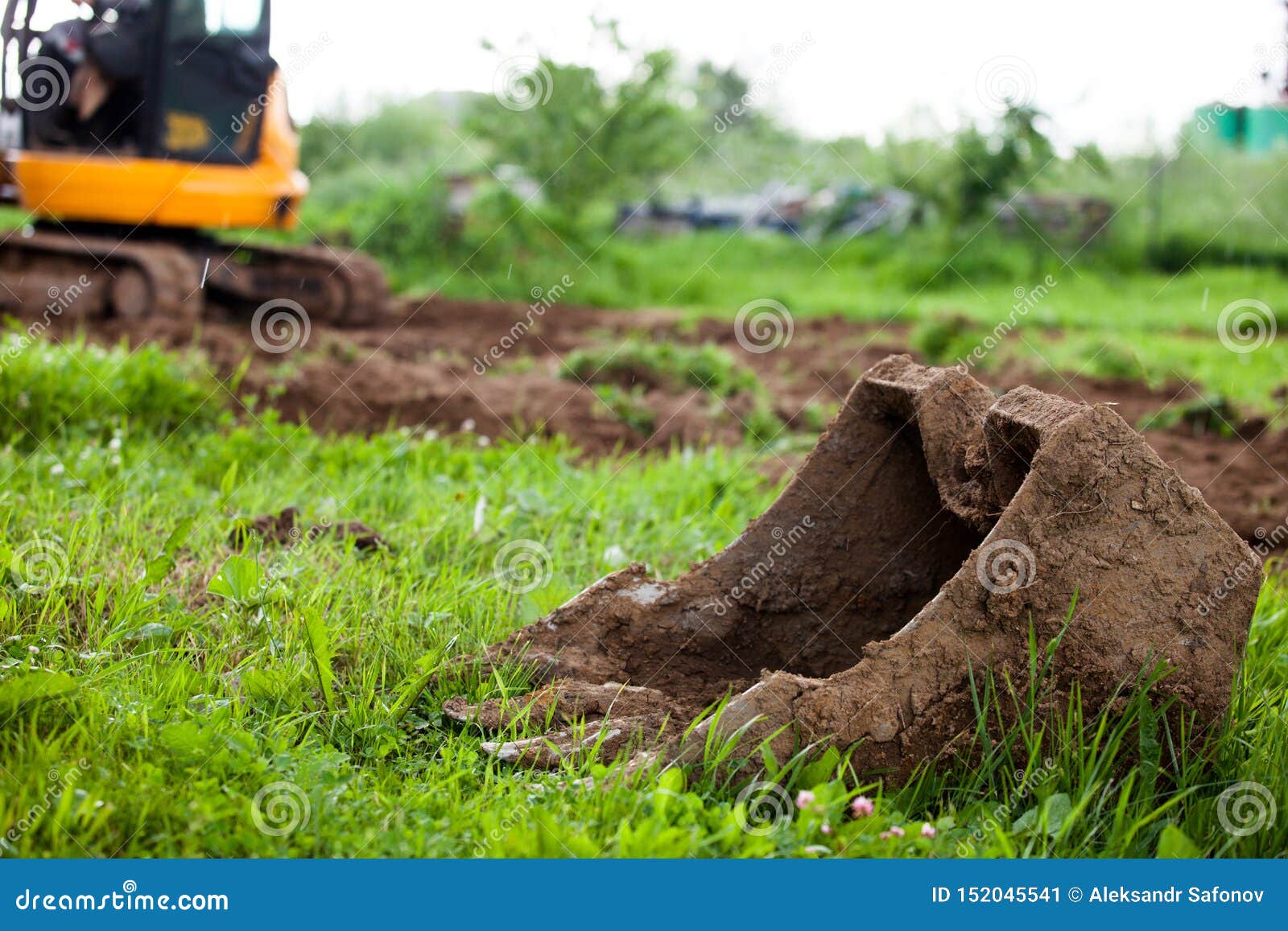 The Excavator Levels the Earth on the Site Stock Image - Image of ...