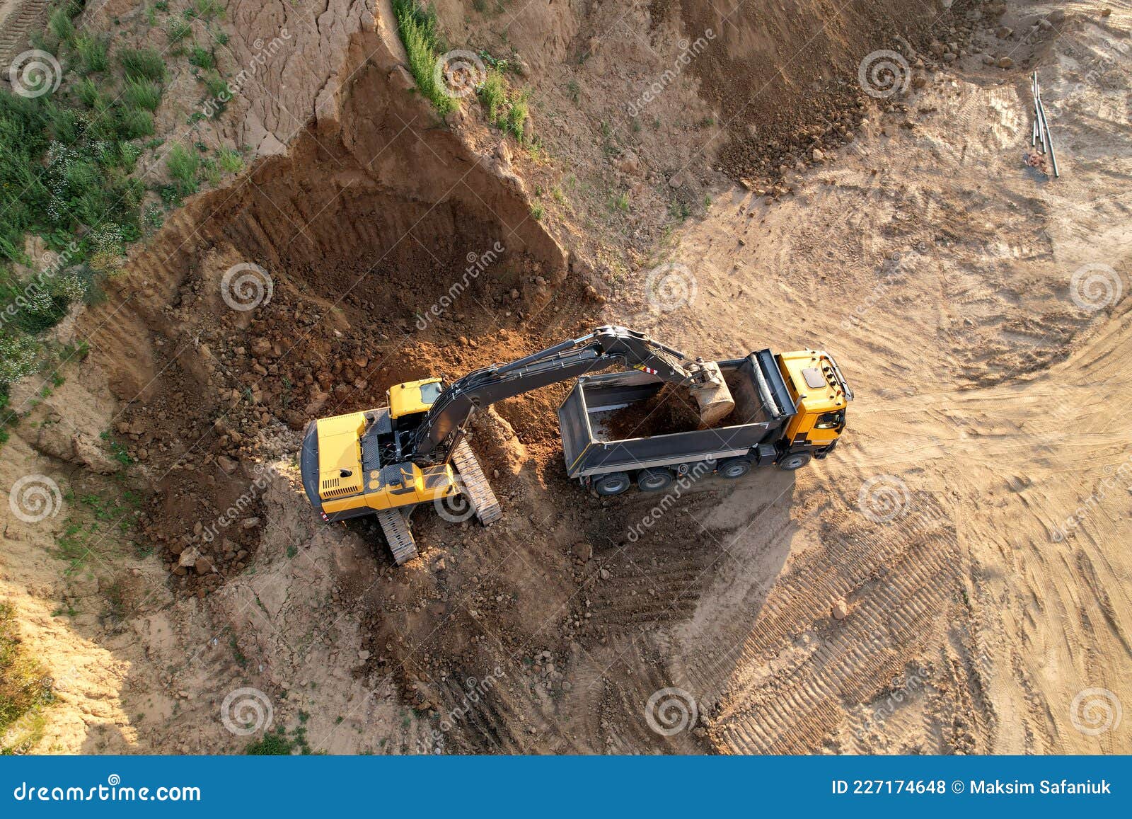 Excavator Load the Sand into Dump Truck. Aerial View of an Backhoe on ...