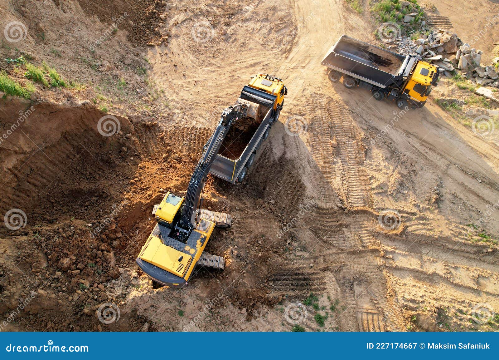 Excavator Load the Sand into Dump Truck. Aerial View of an Backhoe on ...