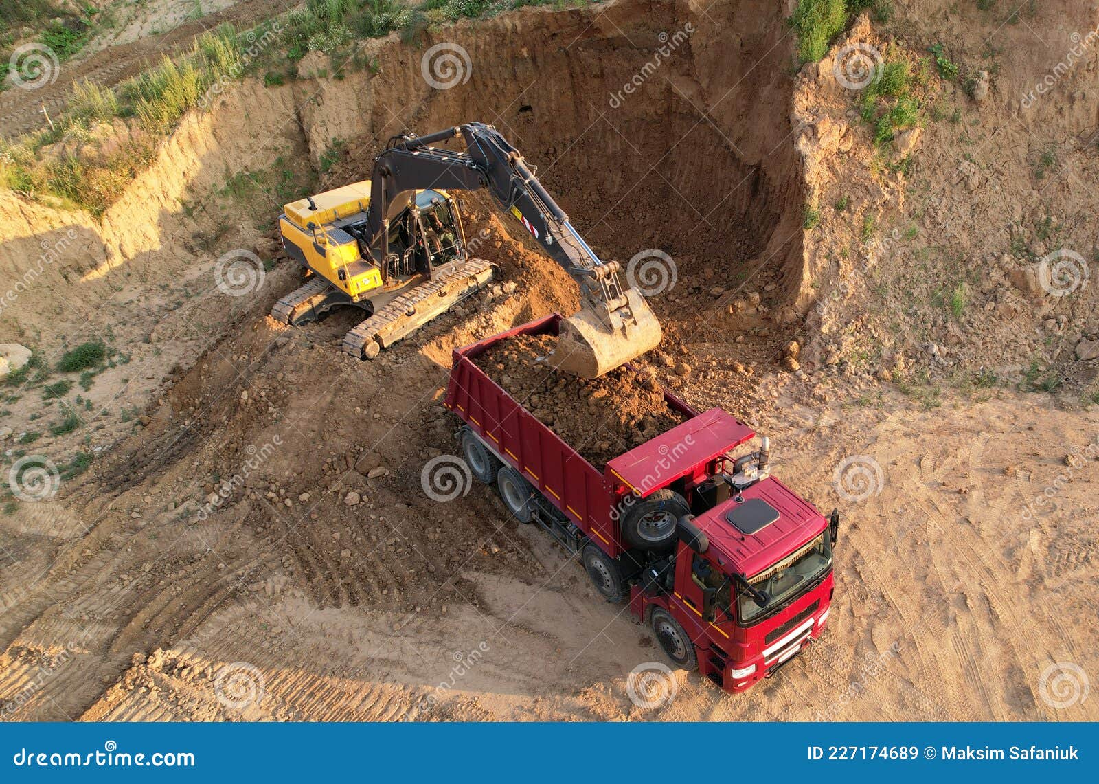 Excavator Load the Sand into Dump Truck. Aerial View of an Backhoe on ...