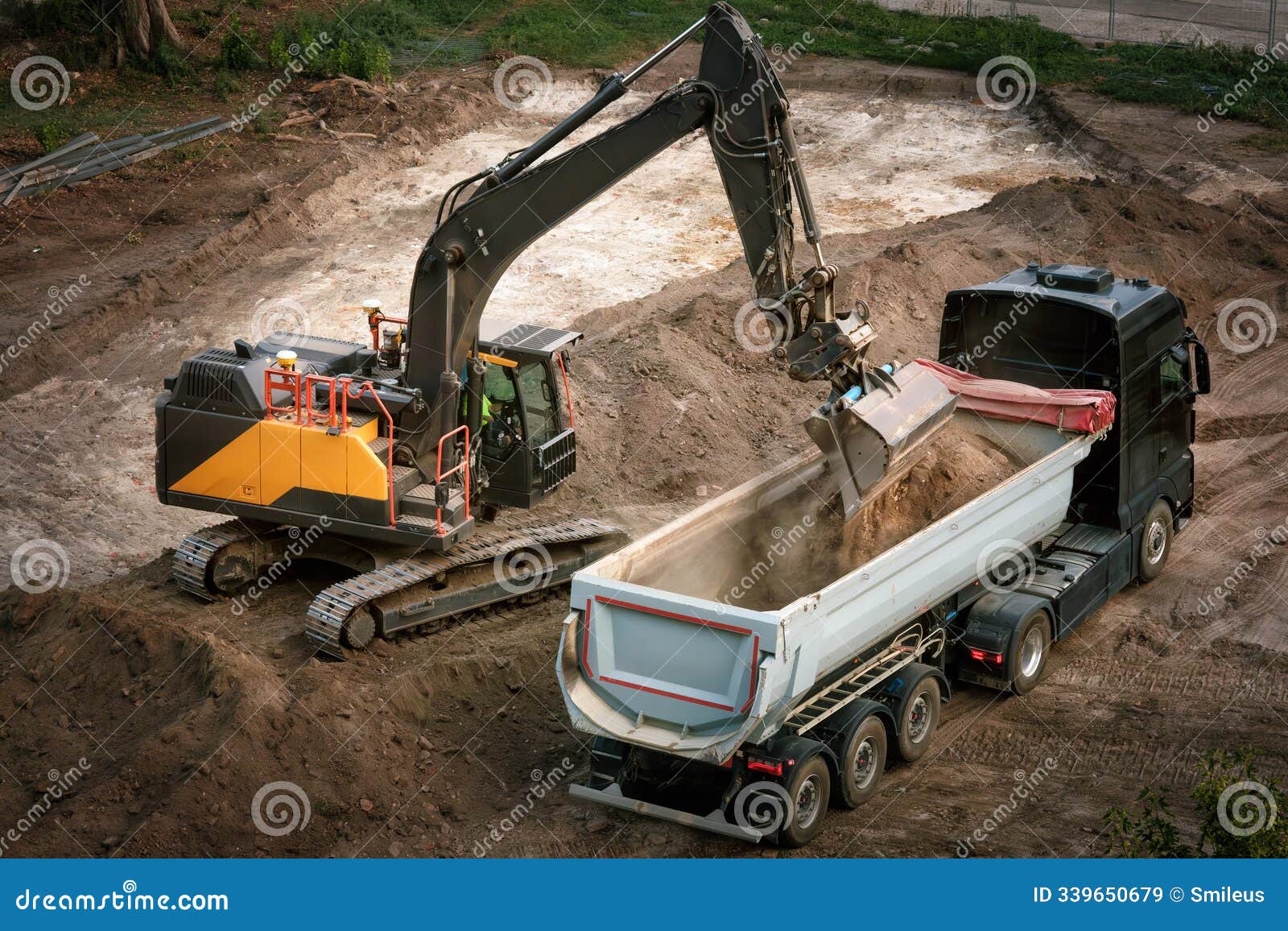 Excavator Loading Dirt into a Truck, View from Above Stock Image ...