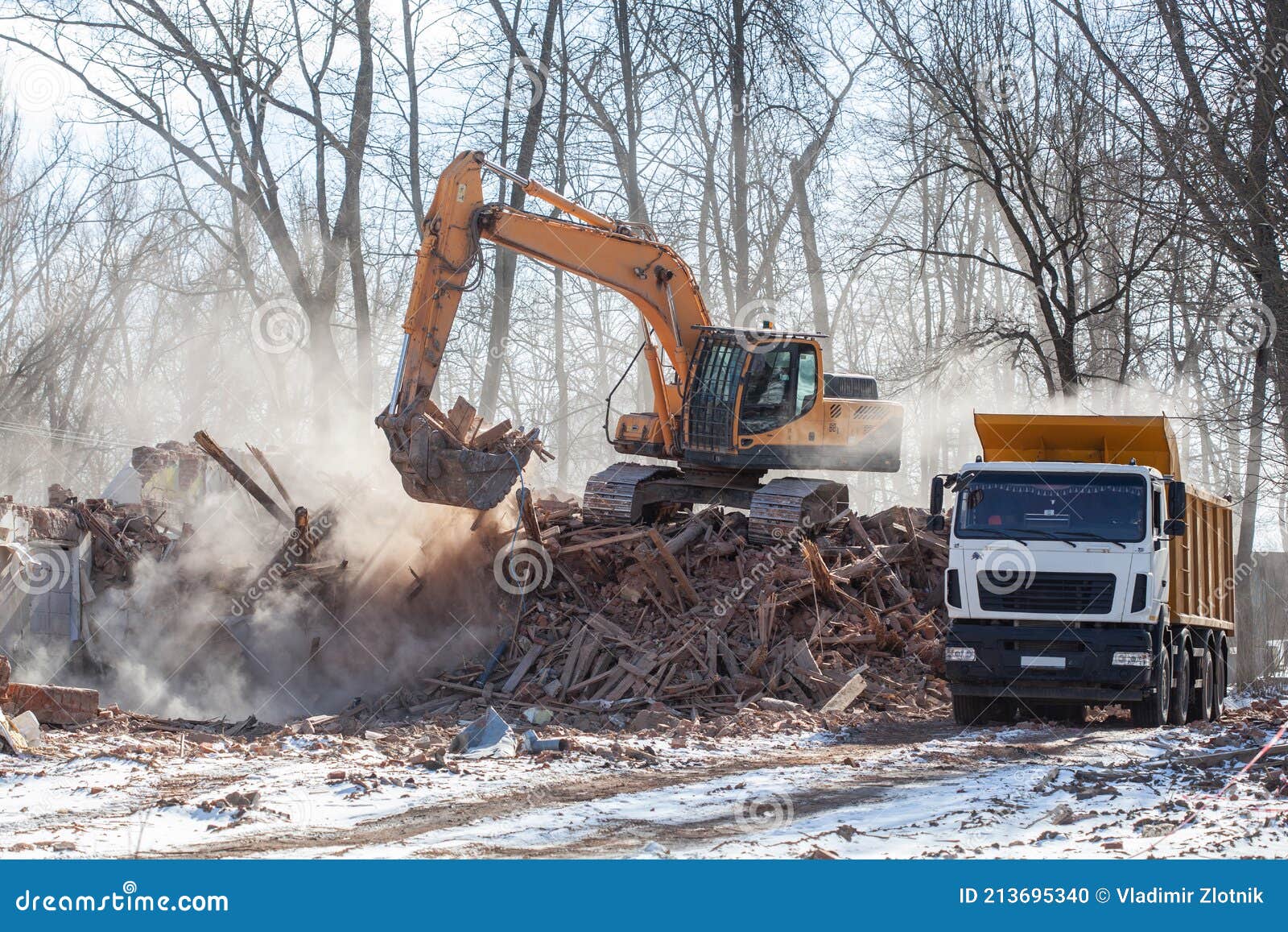 Excavator Loading a Dump Truck with Debris and Trash after Building ...