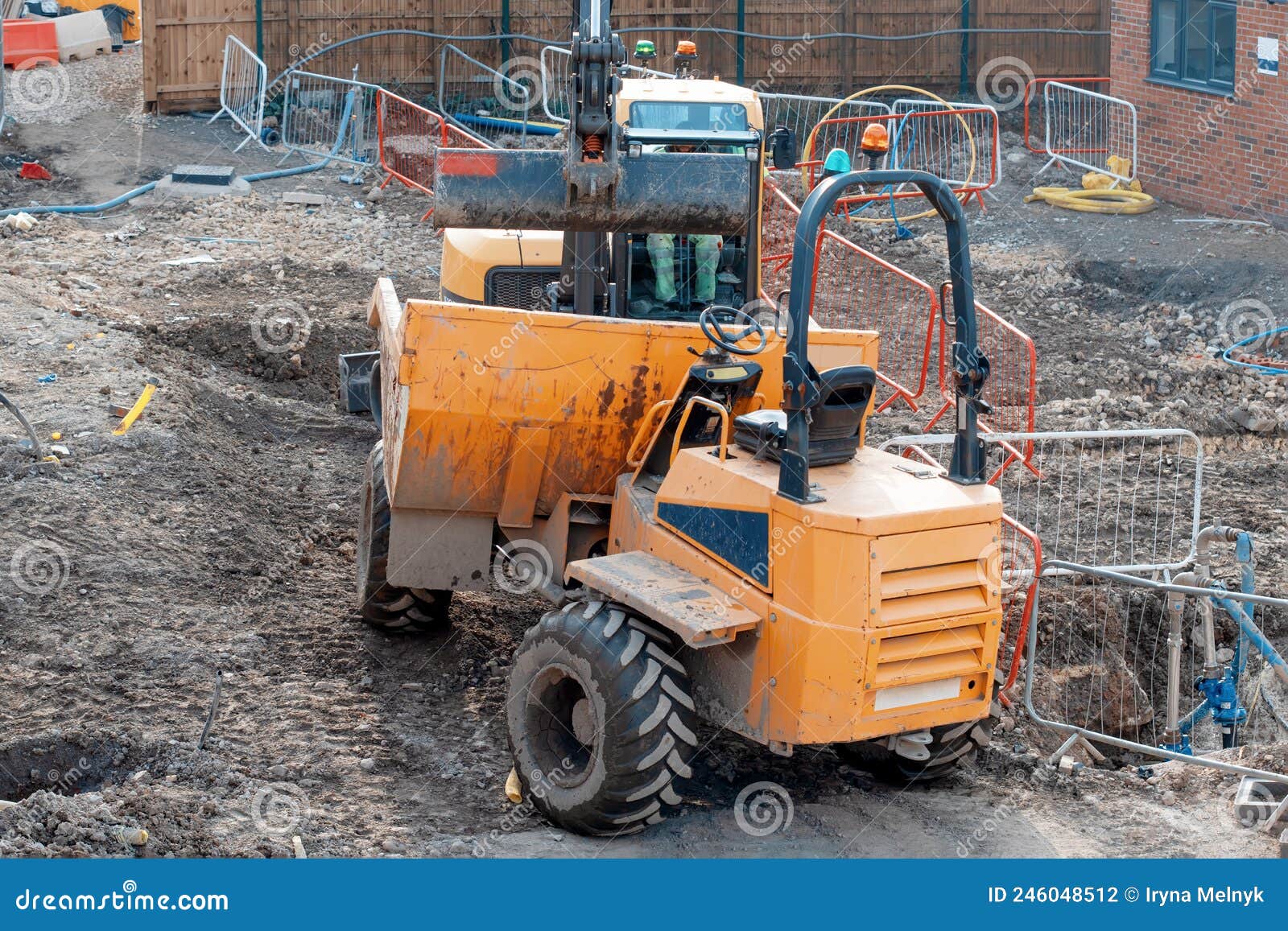 Excavator Loading Dumper during Groundworks on New Residential Housing ...