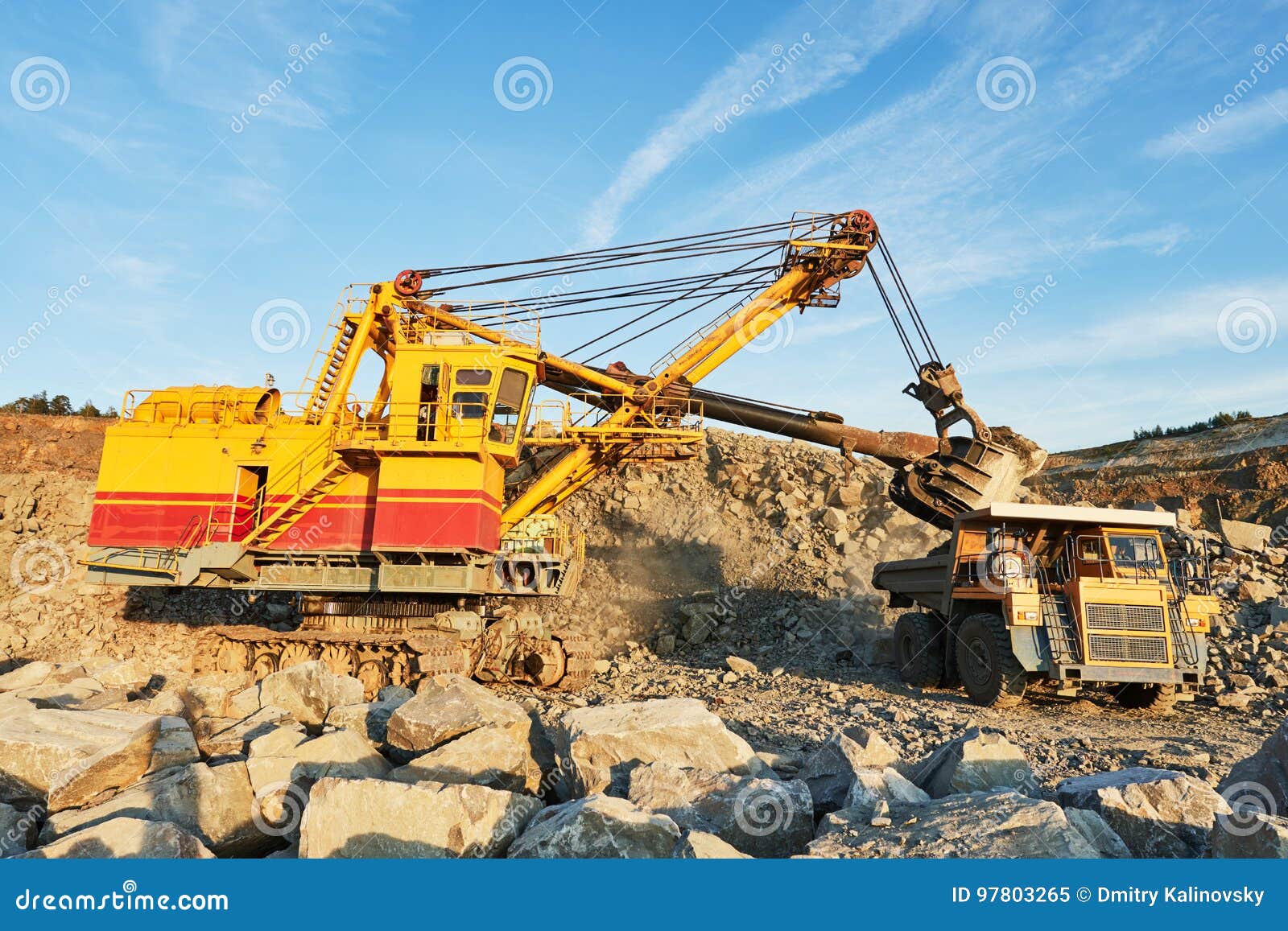 Excavator Loading Granite or Ore into Dump Truck at Opencast Stock ...