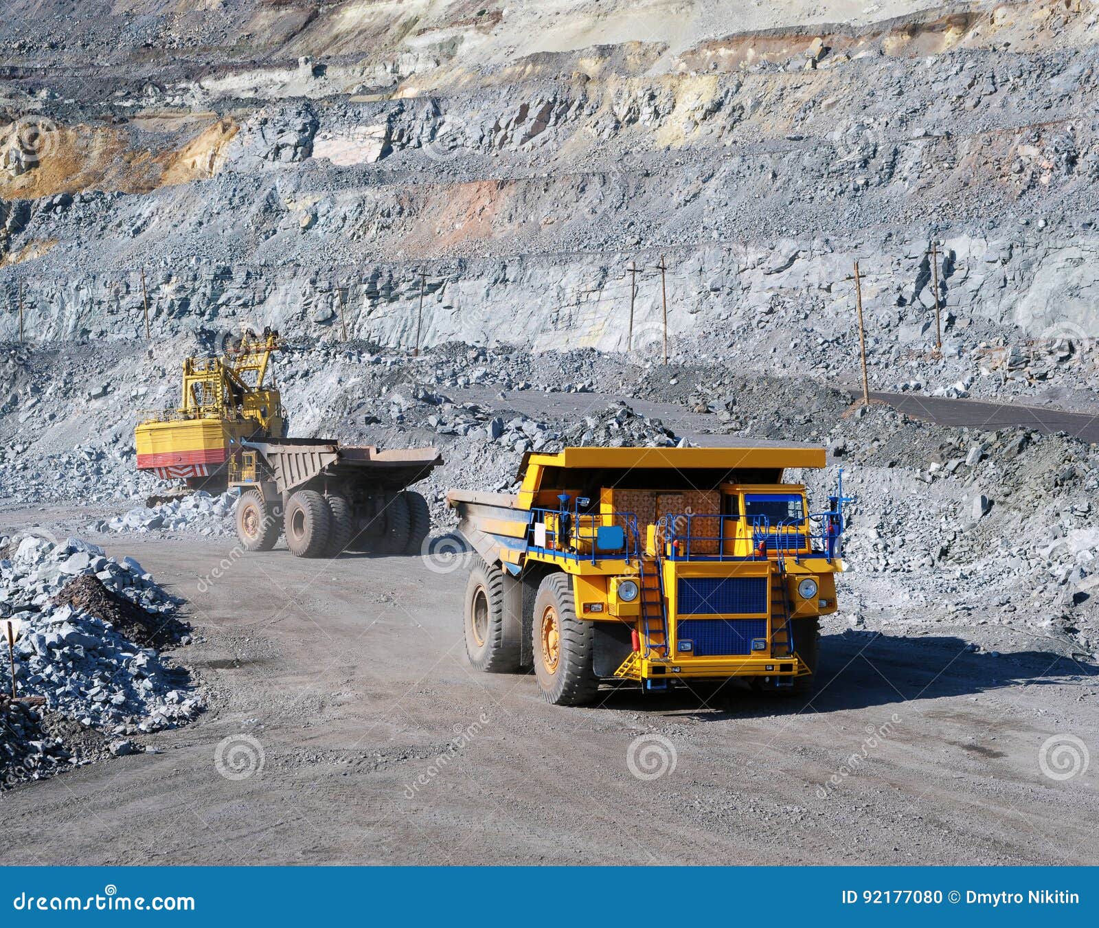 Excavator Loading Iron Ore into Heavy Dump Trucks Stock Photo - Image ...