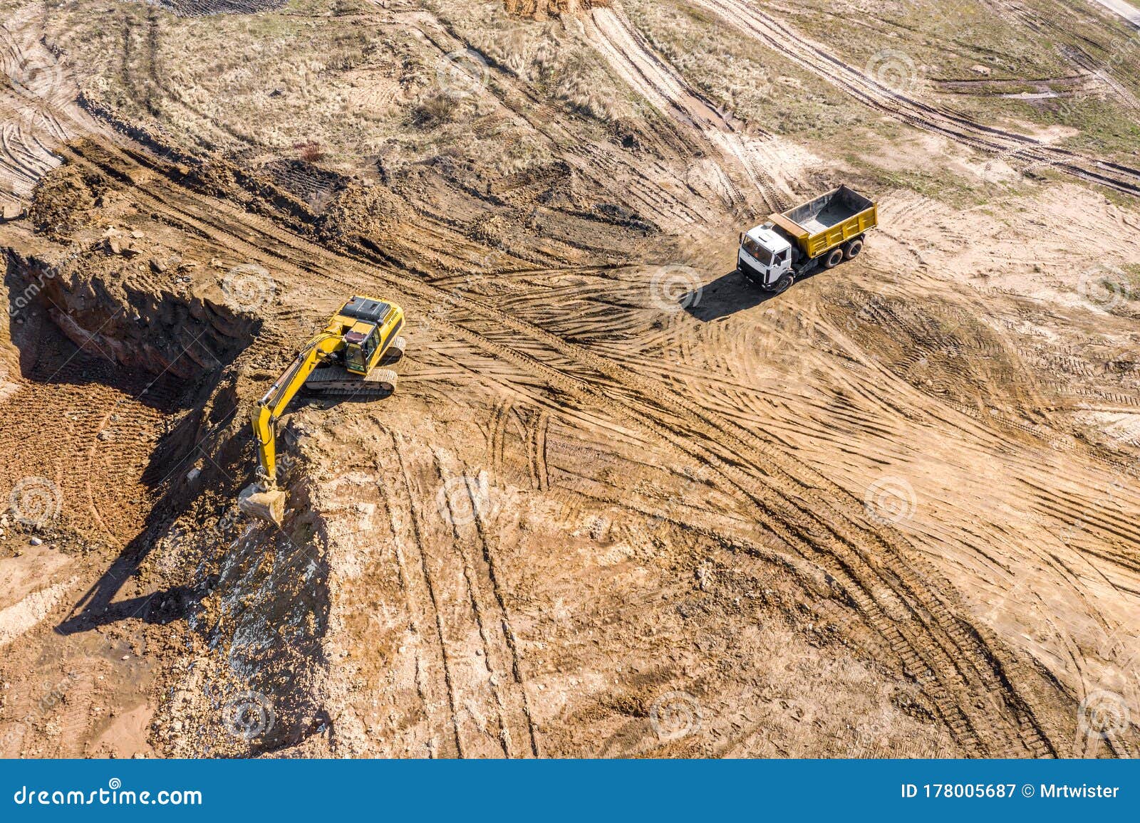 Excavator Loading Sand into the Dump Truck. Construction Site Aerial ...