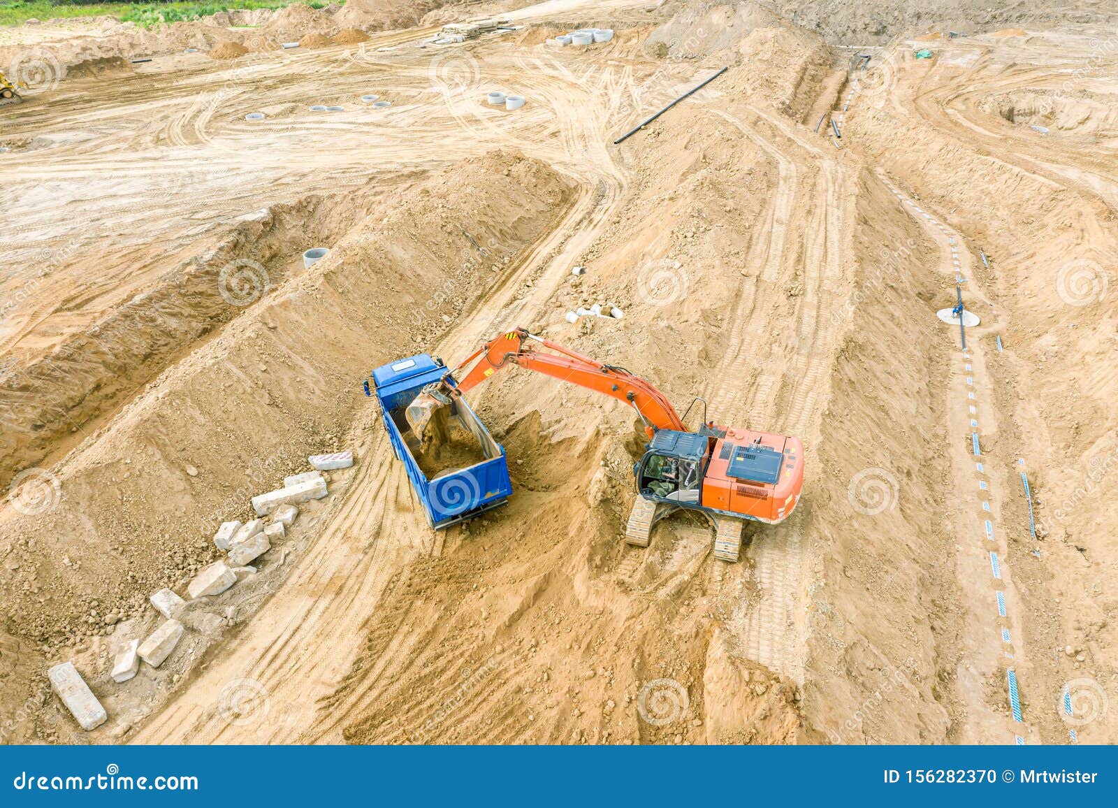 Excavator Loading Sand in Dump Truck at Construction Site Stock Photo ...