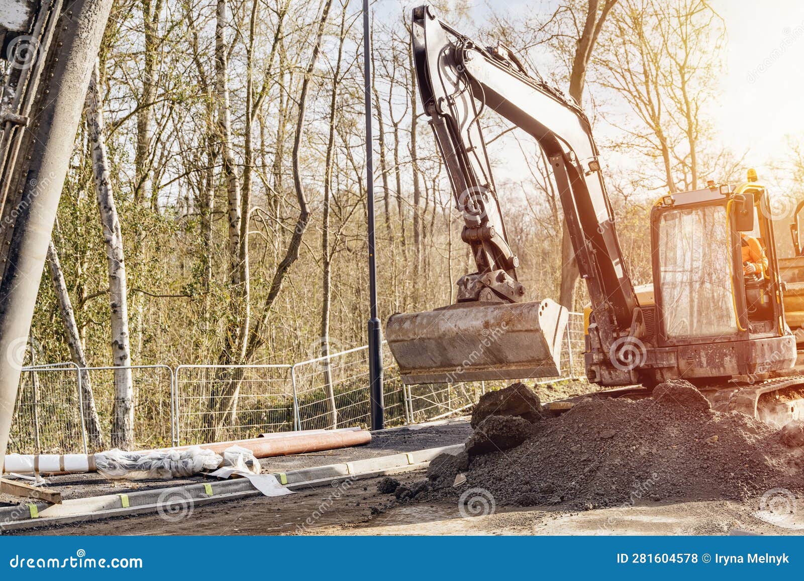 Excavator Loading Semi-dry Concrete Mix into Dumper on Construction ...
