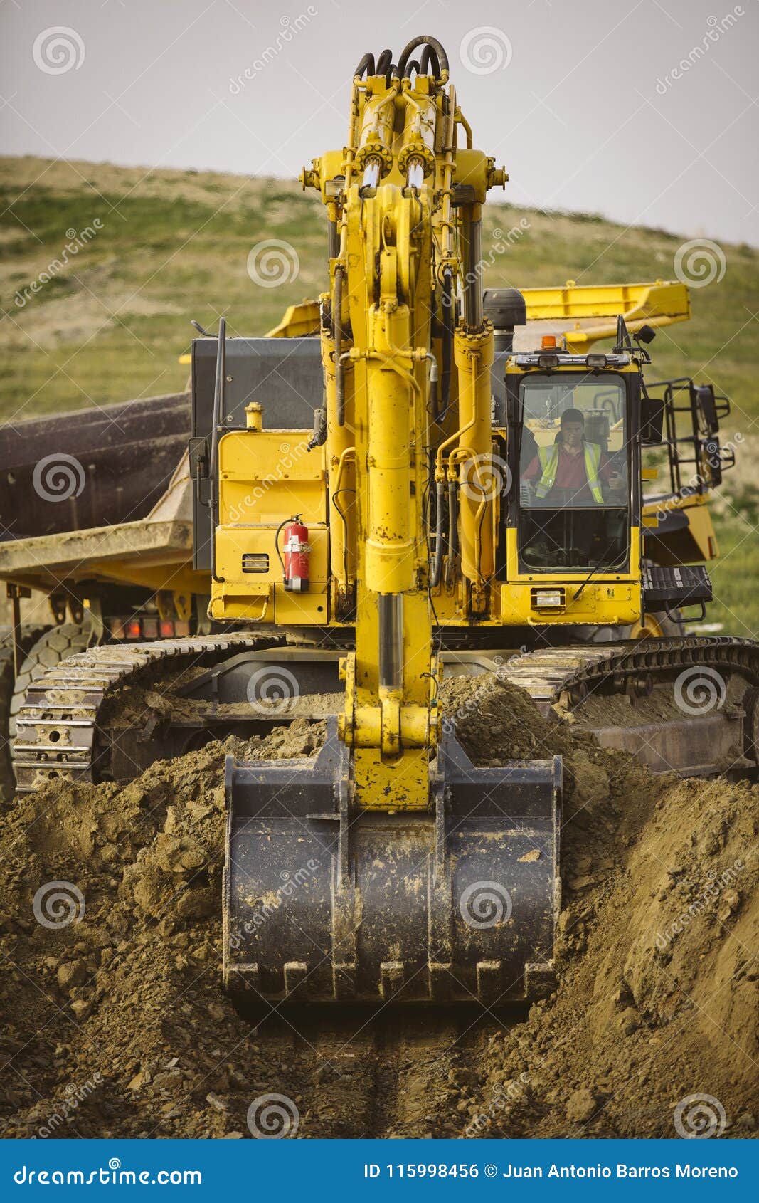 Excavator loading a truck. editorial photo. Image of excavation - 115998456