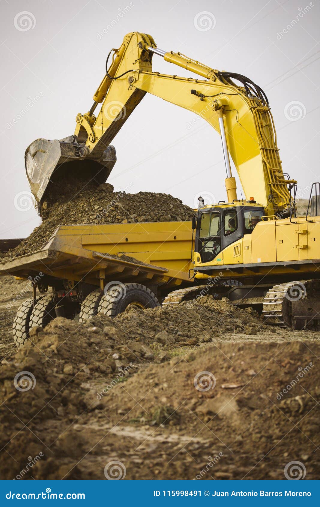 Excavator loading a truck. stock image. Image of moving - 115998491